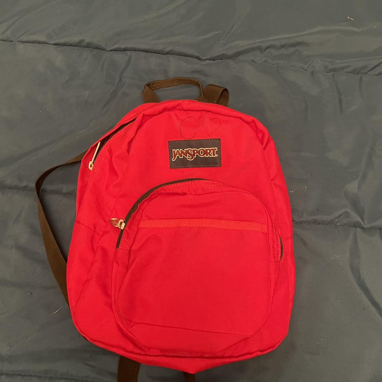 red mini jansport backpack has a c written with... - Depop