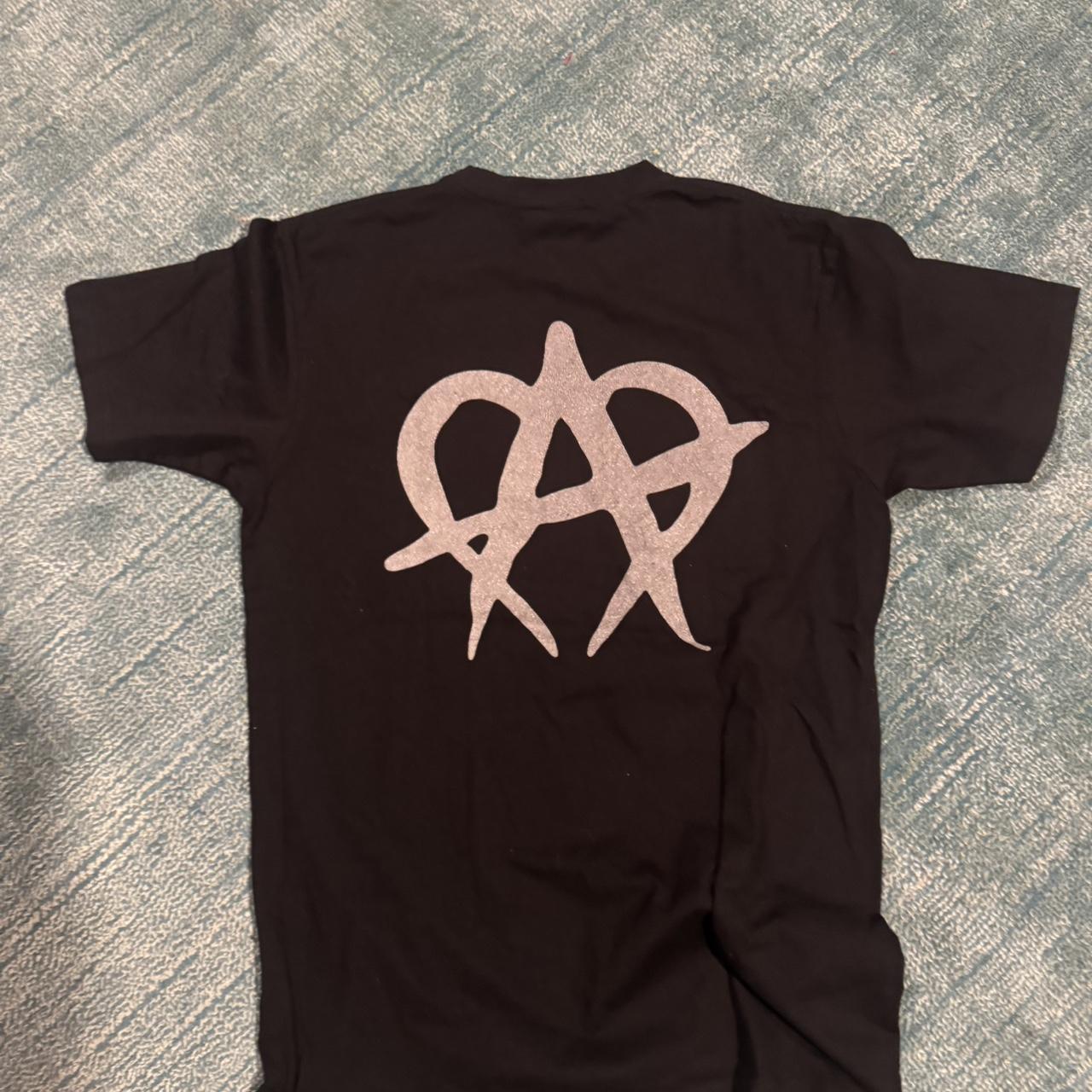 Black and reflective Unmanageable Anarchy logo... | Depop