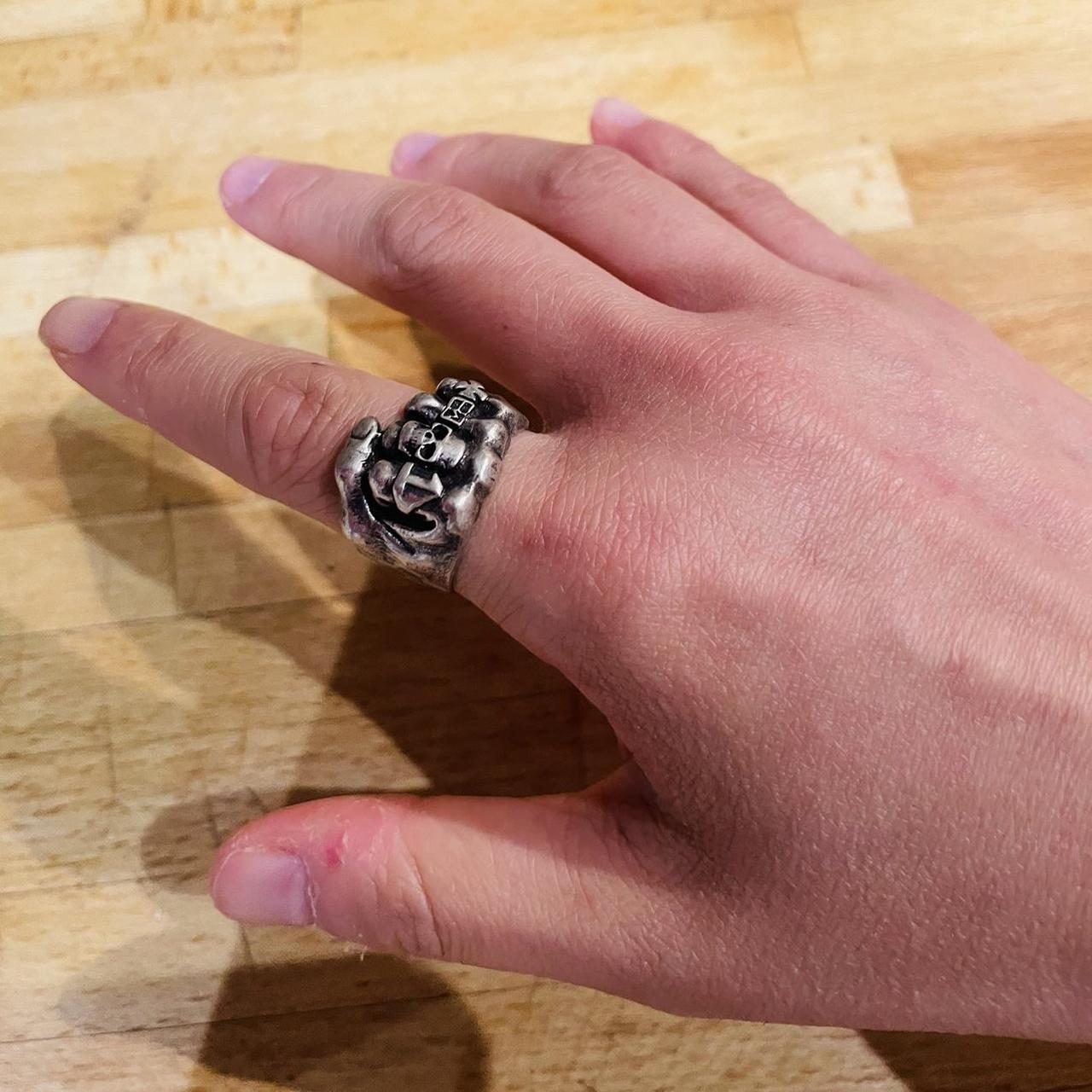 Silver coloured metal fist bump shaped ring with... - Depop