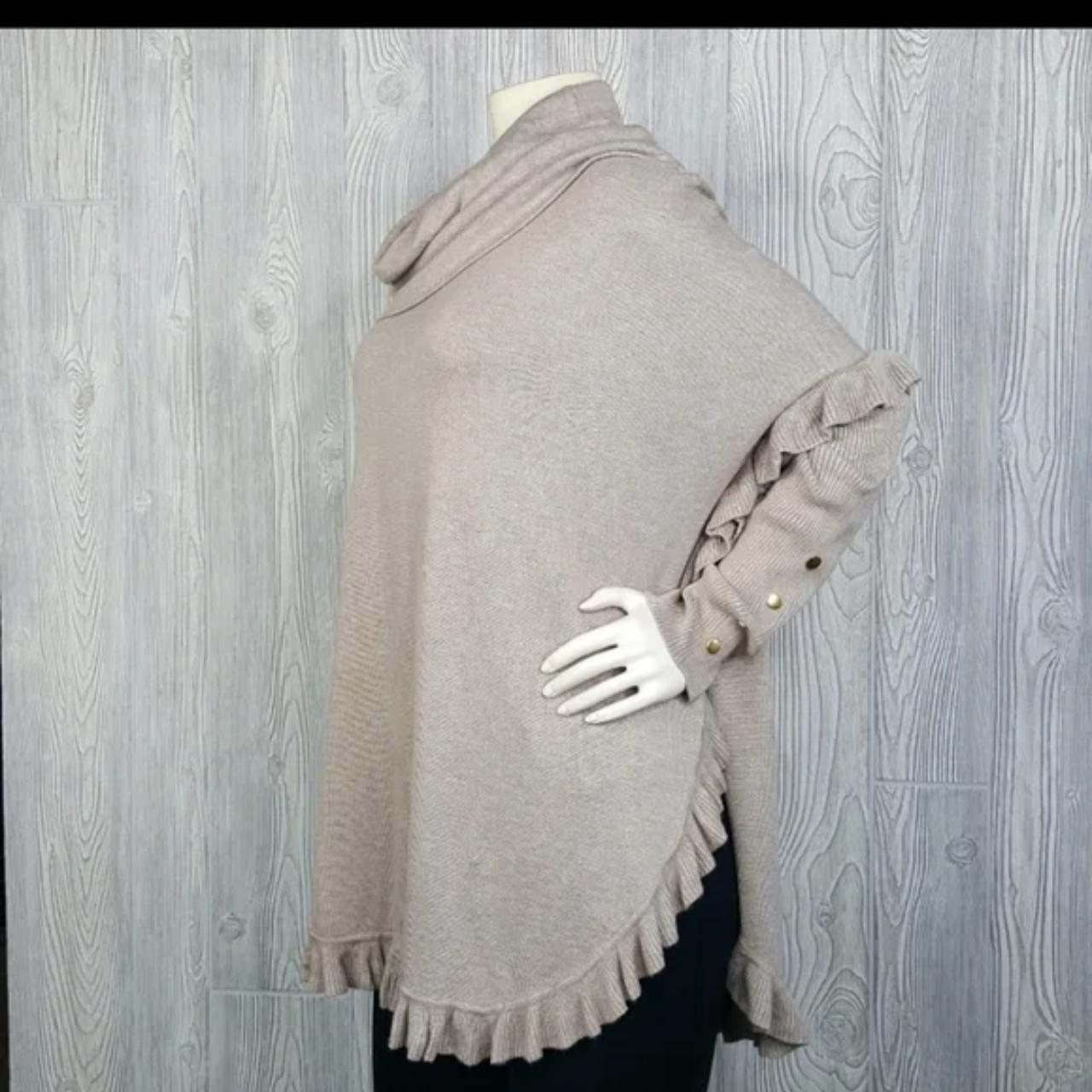 A draped cowl-neck collar flows into split side with... - Depop