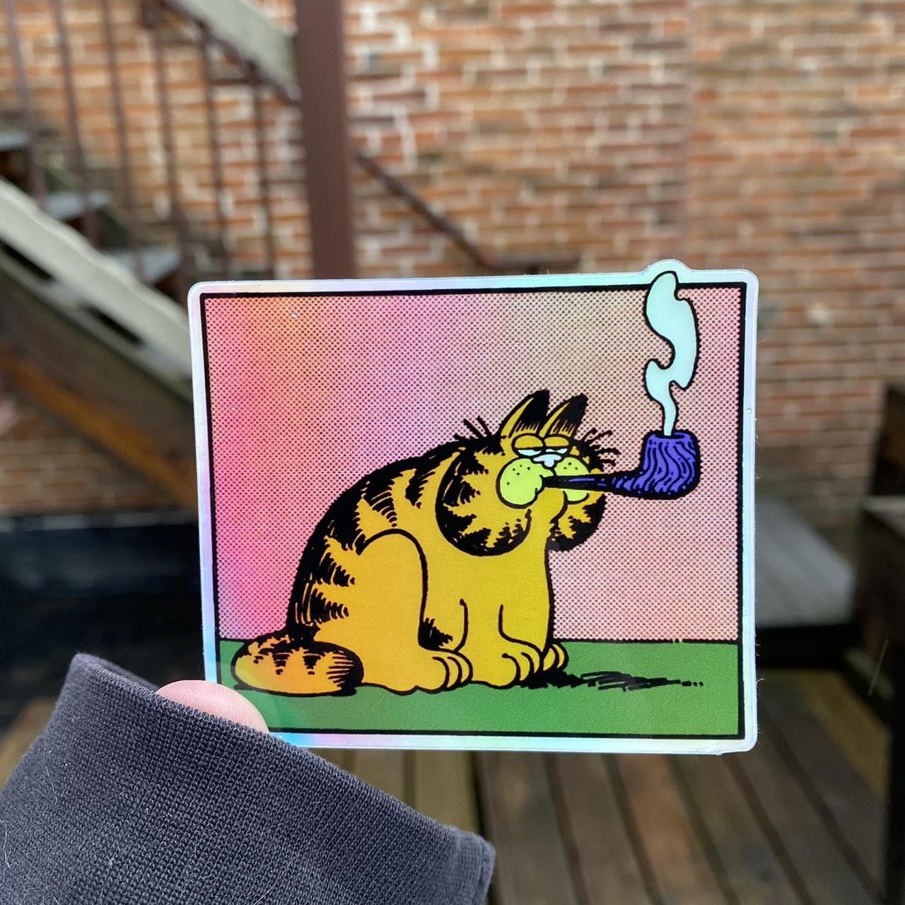 Holographic sticker of Garfield smoking a pipe, from... - Depop