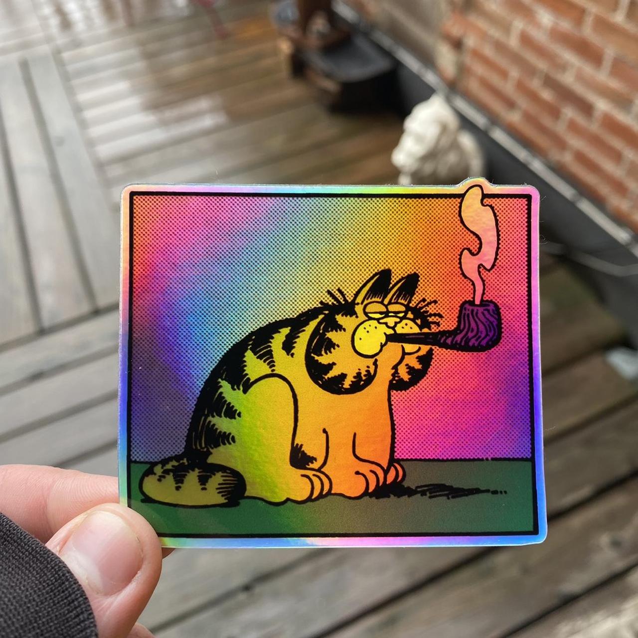 Holographic sticker of Garfield smoking a pipe, from... - Depop