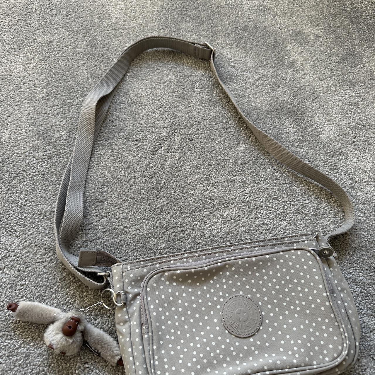 Grey polka dot Kipling bag, lots of pockets.... - Depop
