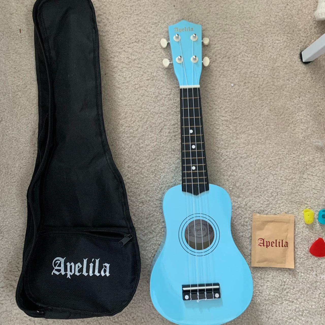 Light blue ukulele with strings, pick and, fingertip... - Depop