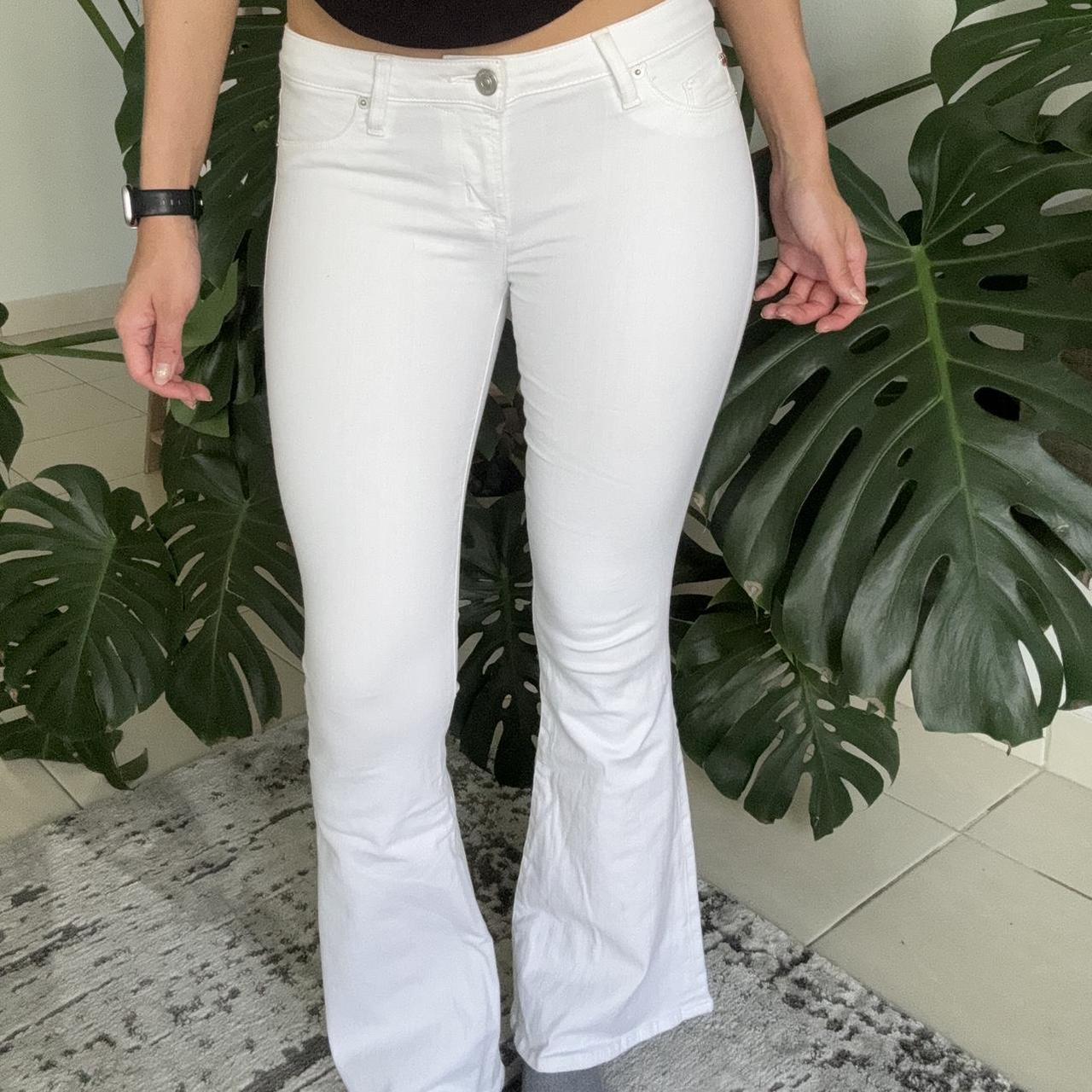 Low rise White flared jeans with a little bit of... - Depop