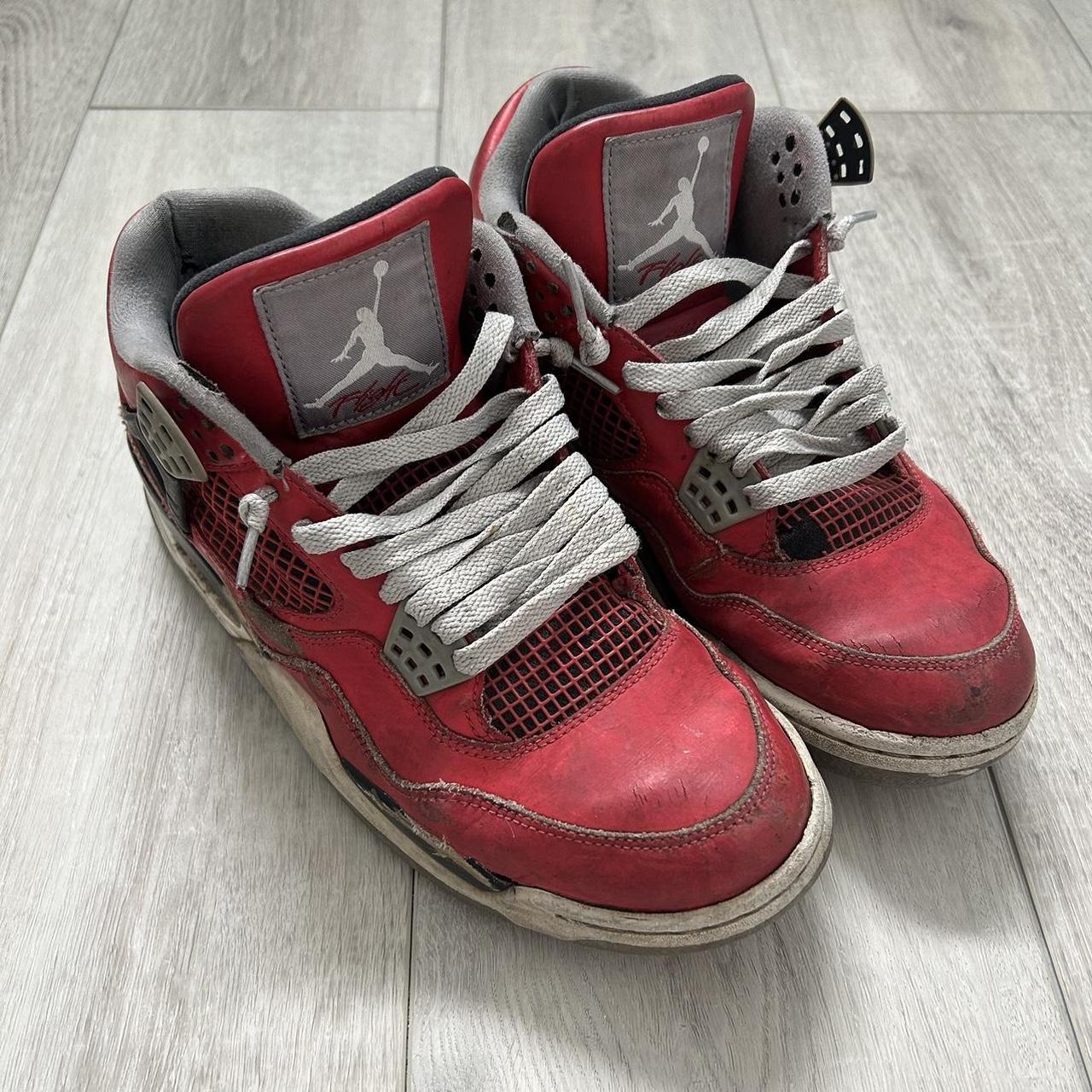 Beat up red toro bravos Jordan 4s | Depop