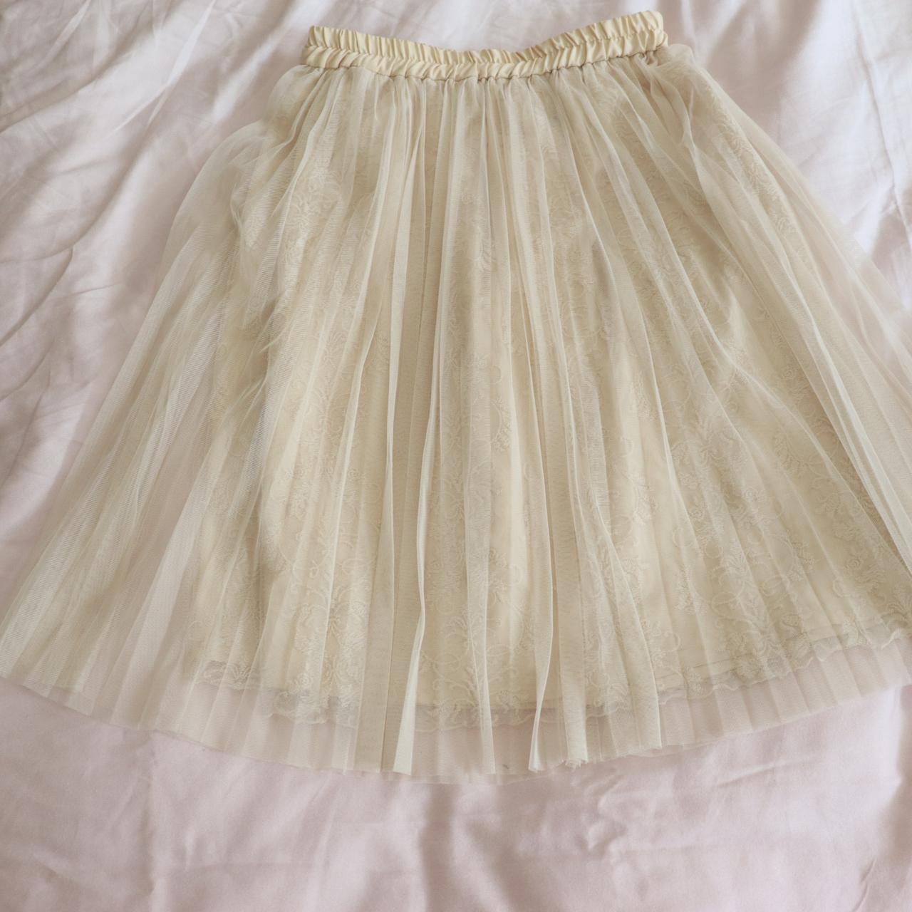 This beige layered tulle and lace skirt from axes... - Depop