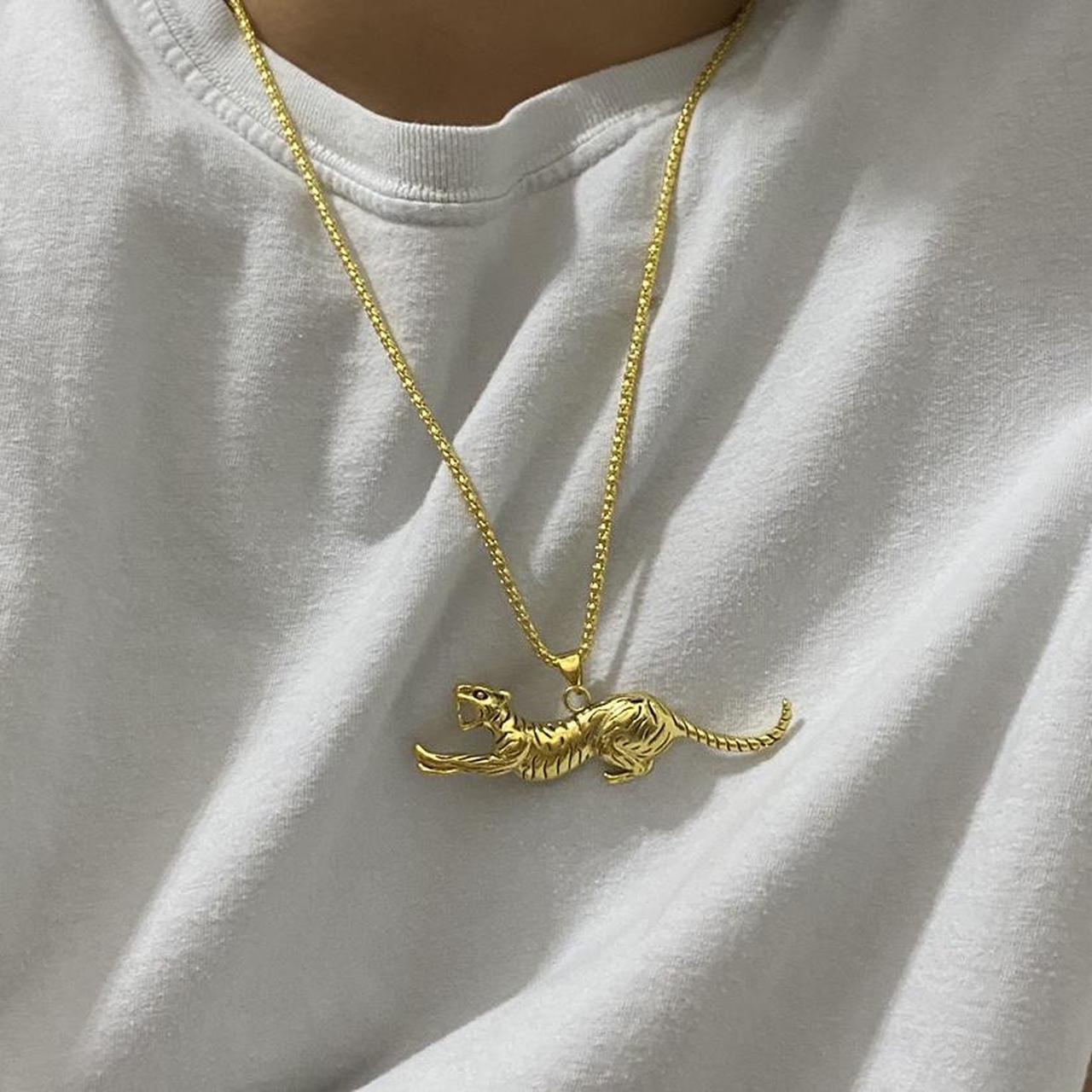 gold running tiger necklace 23” chain - Depop