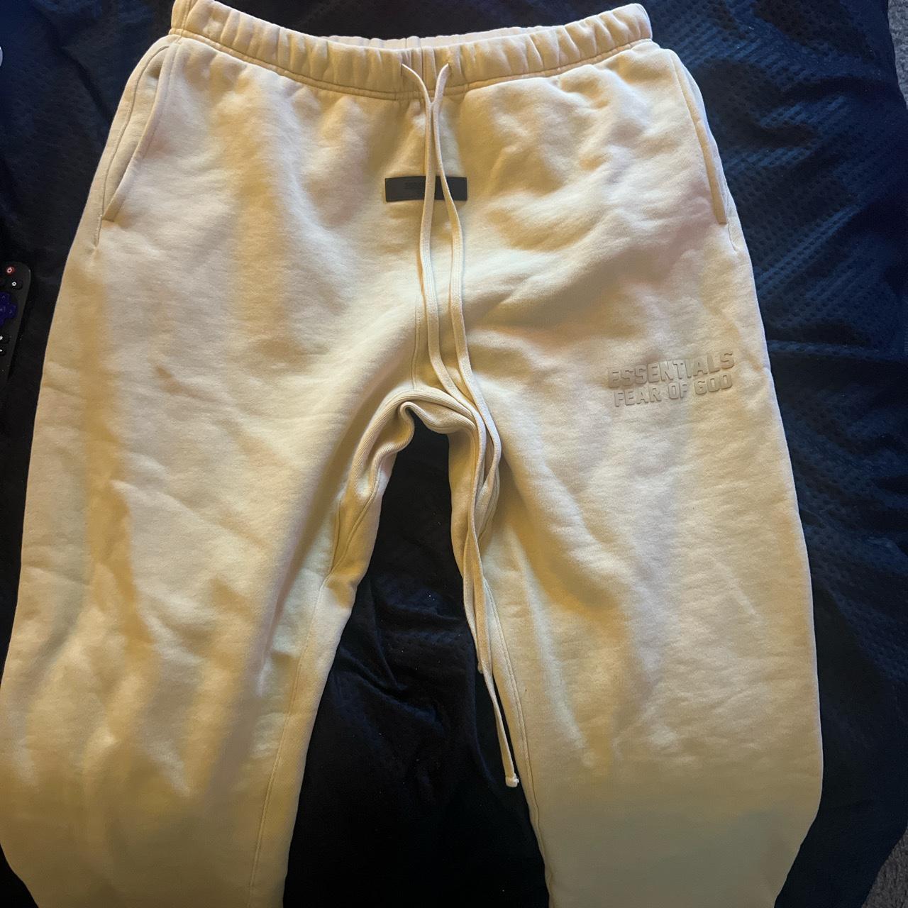 Yellow Essentials fear of god sweats, worn once size... - Depop