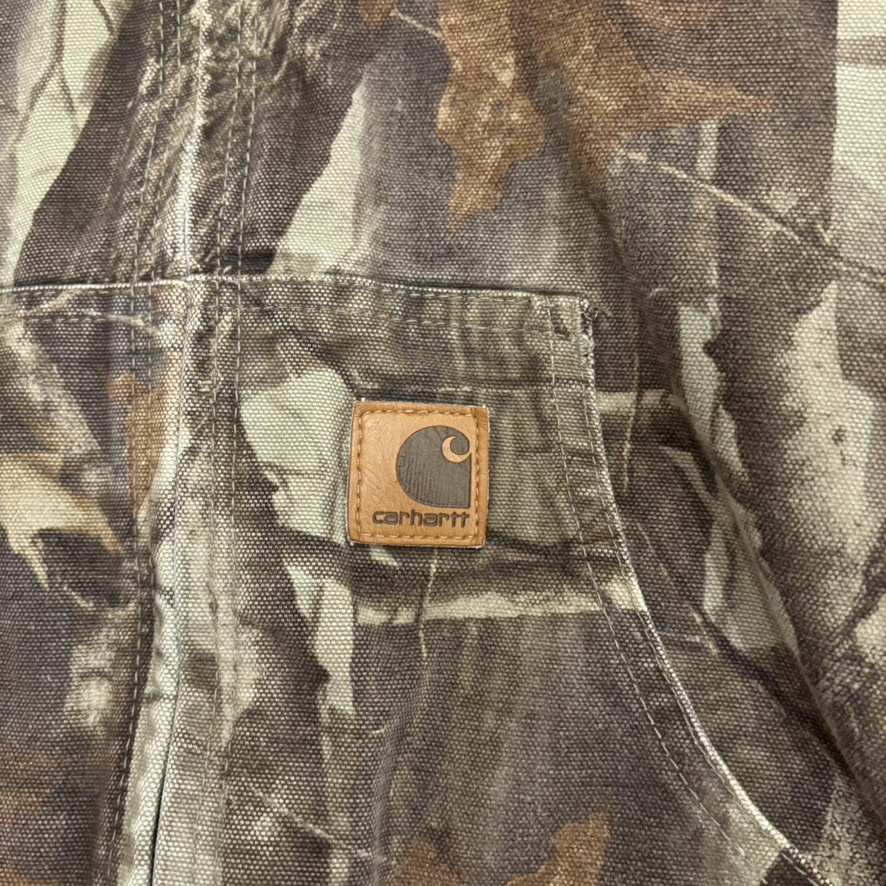 Carhartt camo jacket no size tags, measures to... - Depop