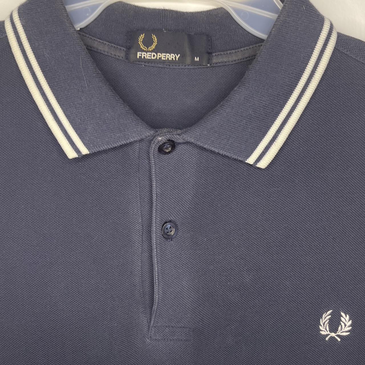 Fred Perry. Navy Blue polo. White logo, white stripes. - Depop