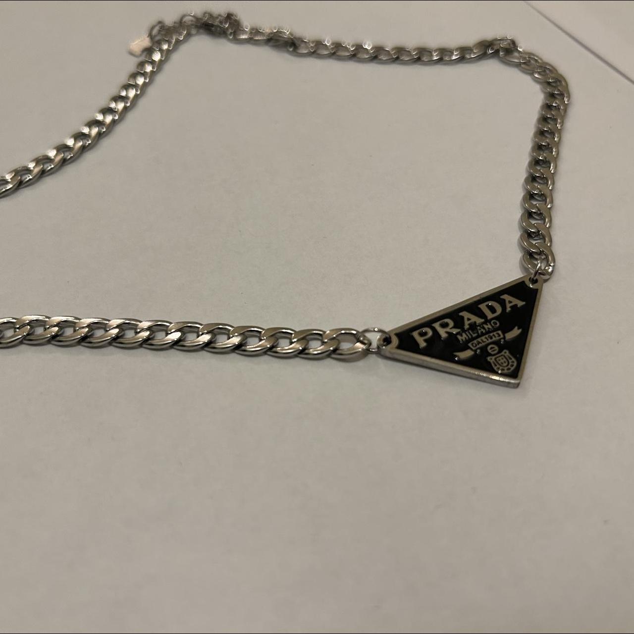 Prada triangle necklace. Never worn without box.... - Depop