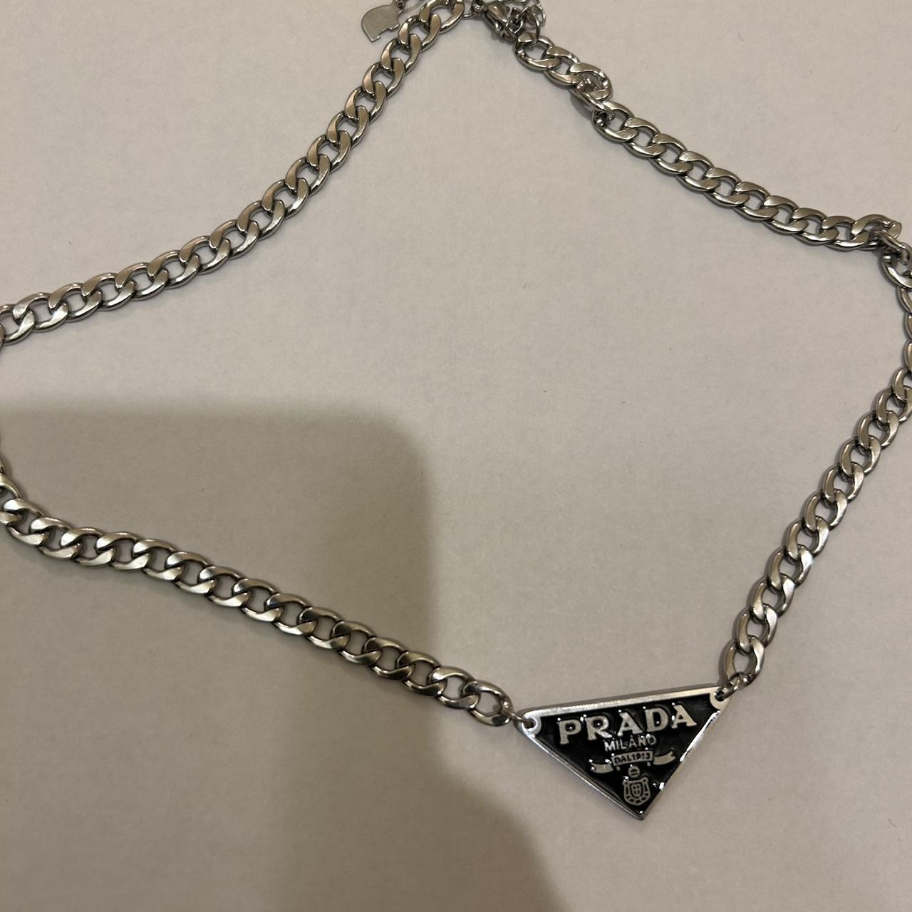 Prada triangle necklace. Never worn without box.... - Depop
