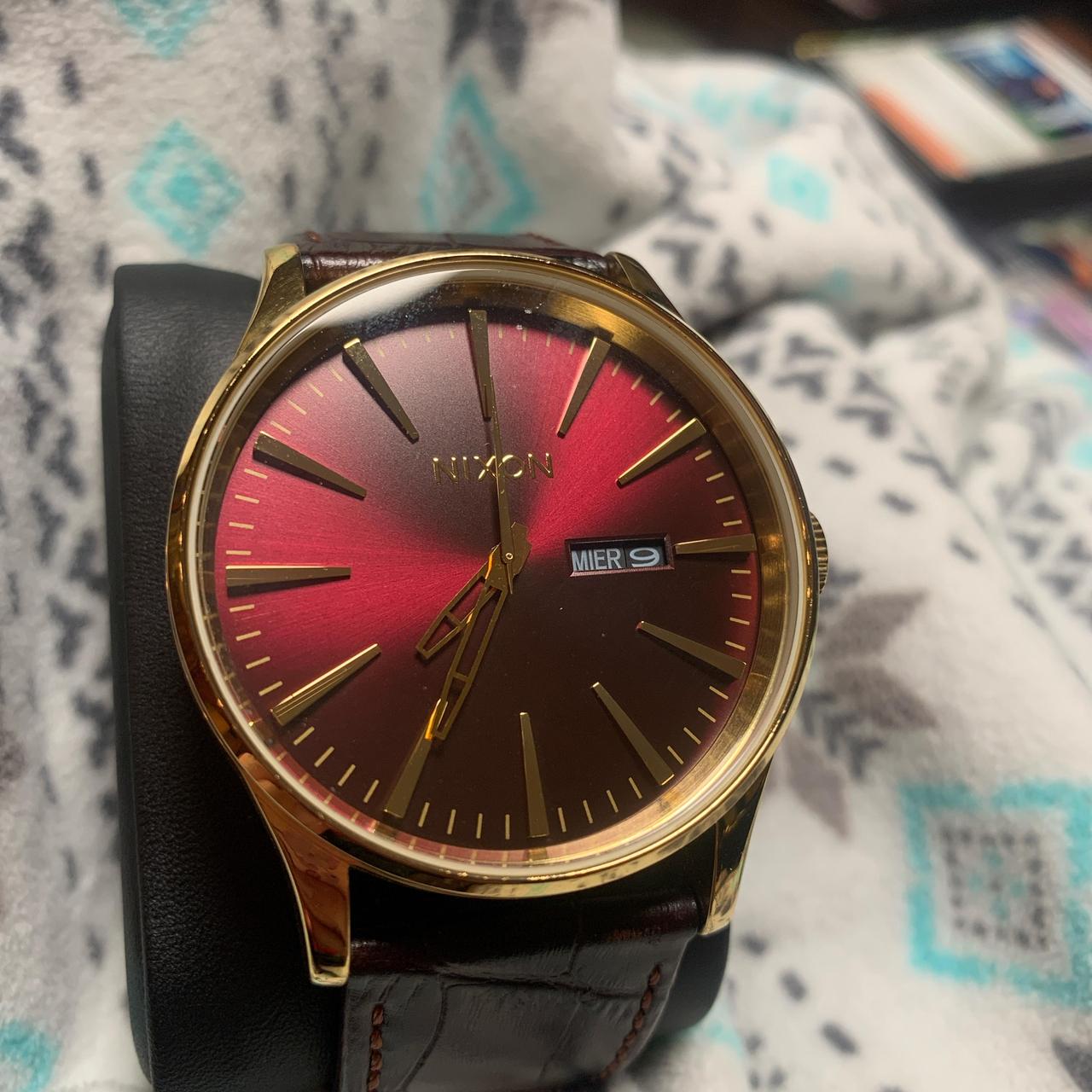 Stylish Nixon watch with red and gold accents... - Depop