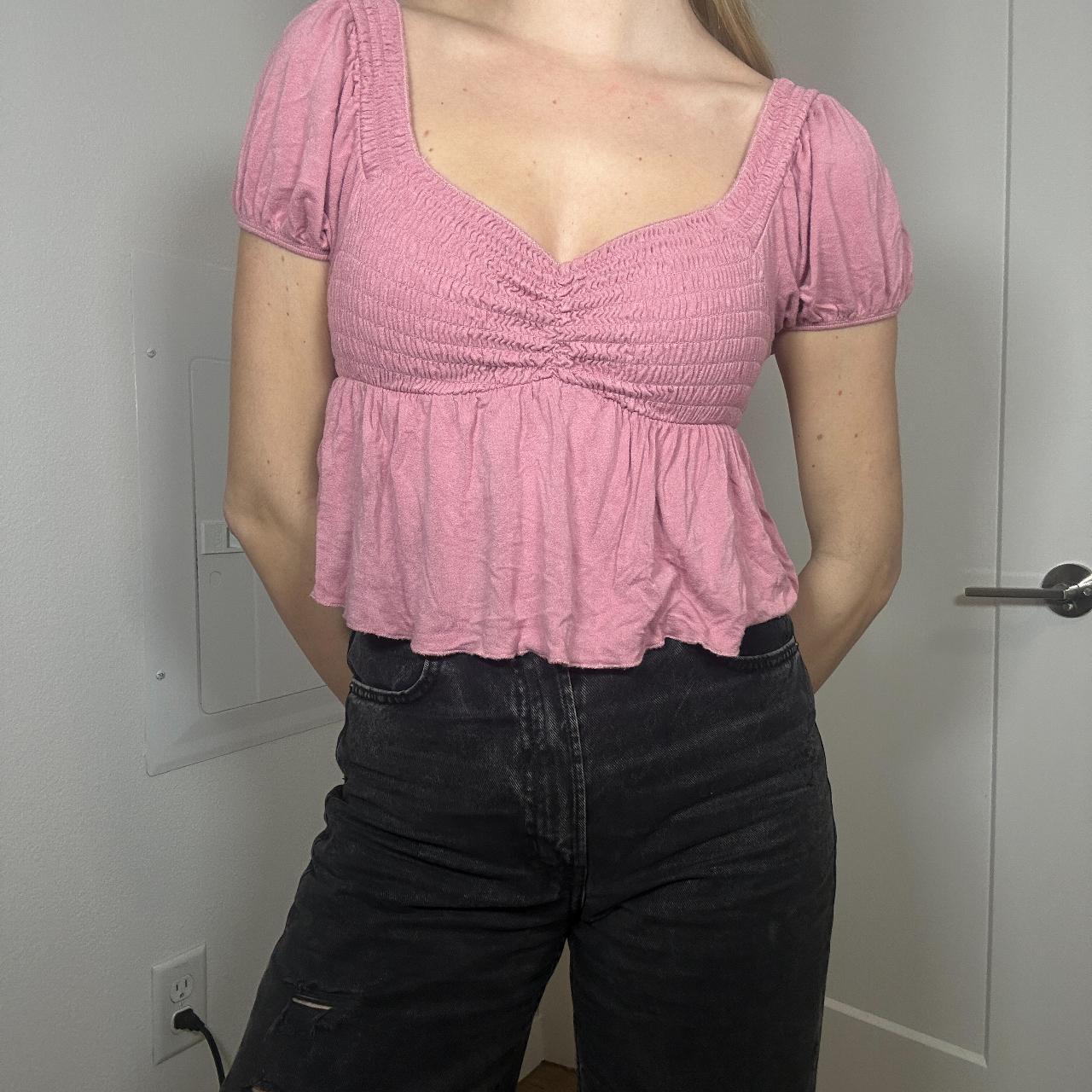 Pink top with a tight torso fit and shoulders that... - Depop