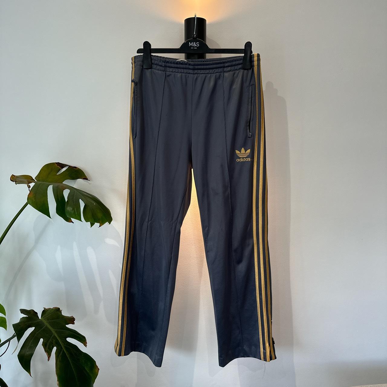 Vintage Adidas Grey/Gold tracksuit bottoms. Zip at... - Depop