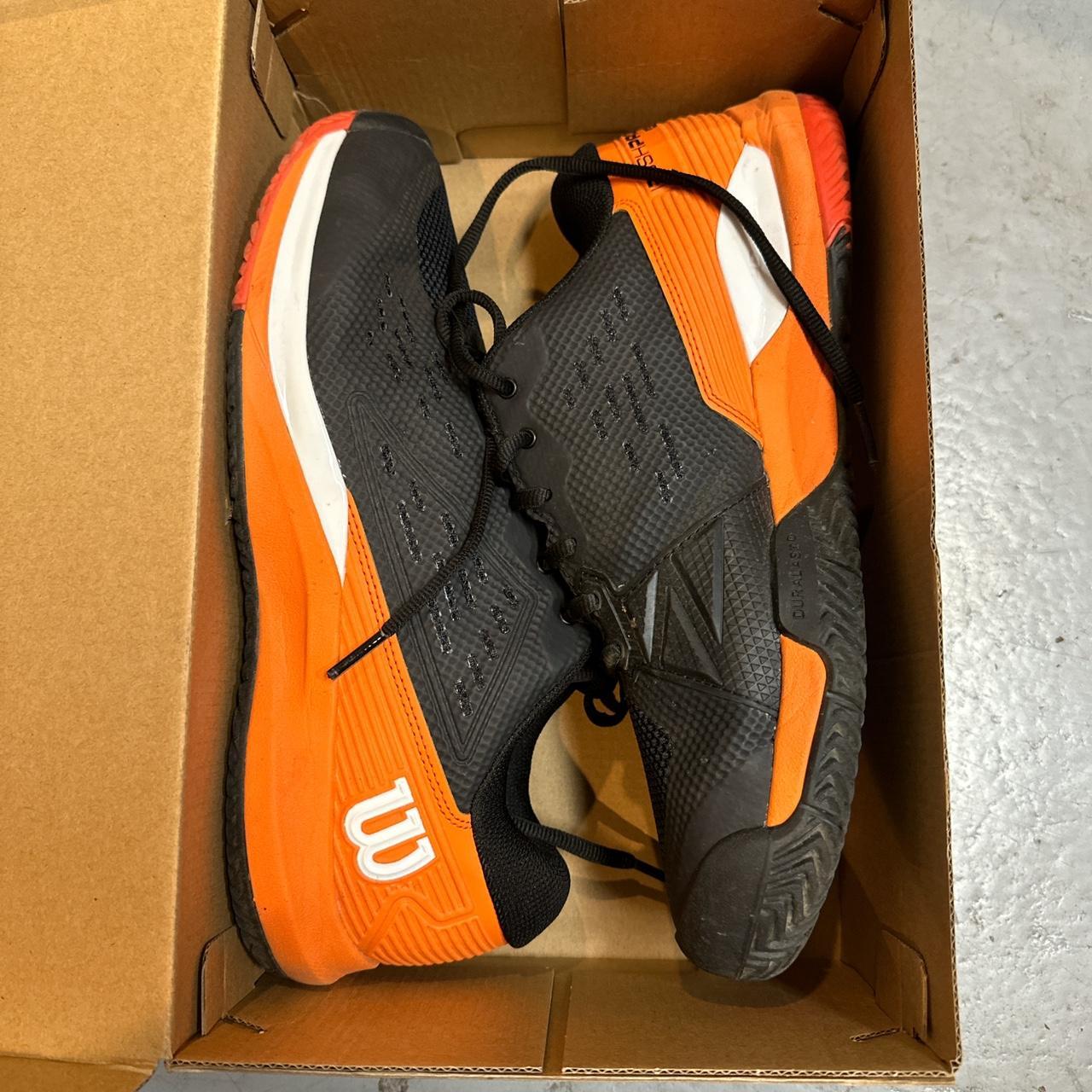 Wilson orange and black tennis shoes, hardly worn - Depop