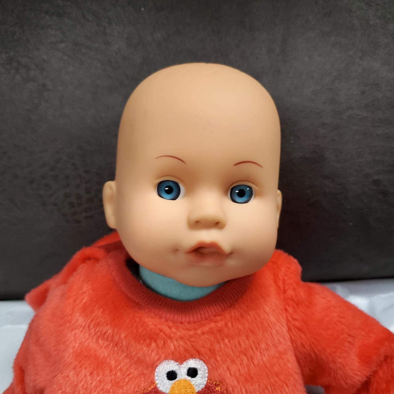 This adorable baby doll is dressed in a bright red... - Depop