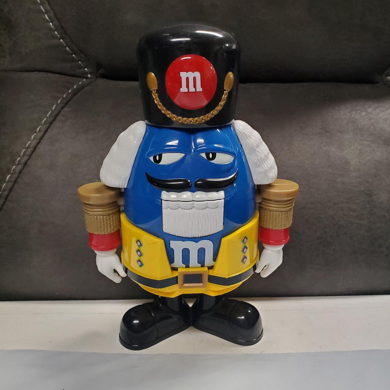 This M&M's candy dispenser features a blue M&M... - Depop