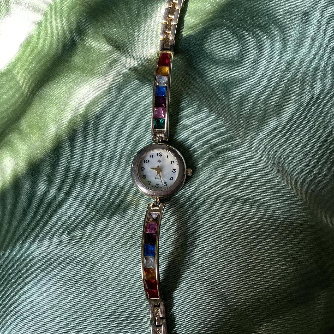 Gold tone watch with multicolored crystal bracelet... - Depop
