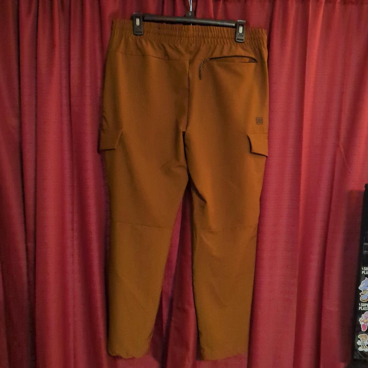 Stretchy burnt orange FLX cargo pants. - Depop