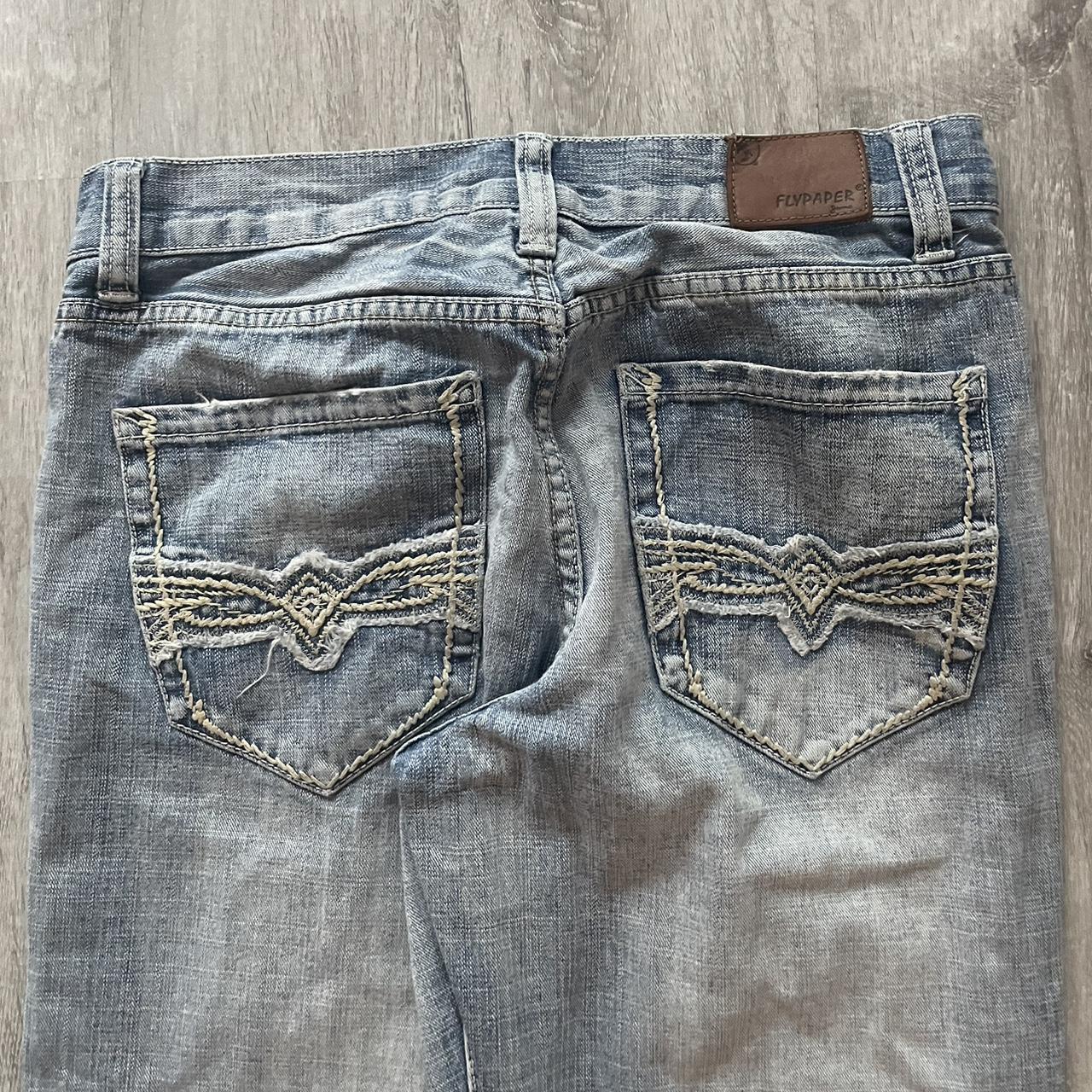 light wash flared flypaper jeans with embroidered... - Depop