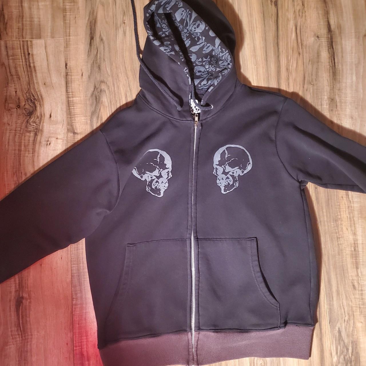 Black zip-up skull hoodie with skull designs in... - Depop