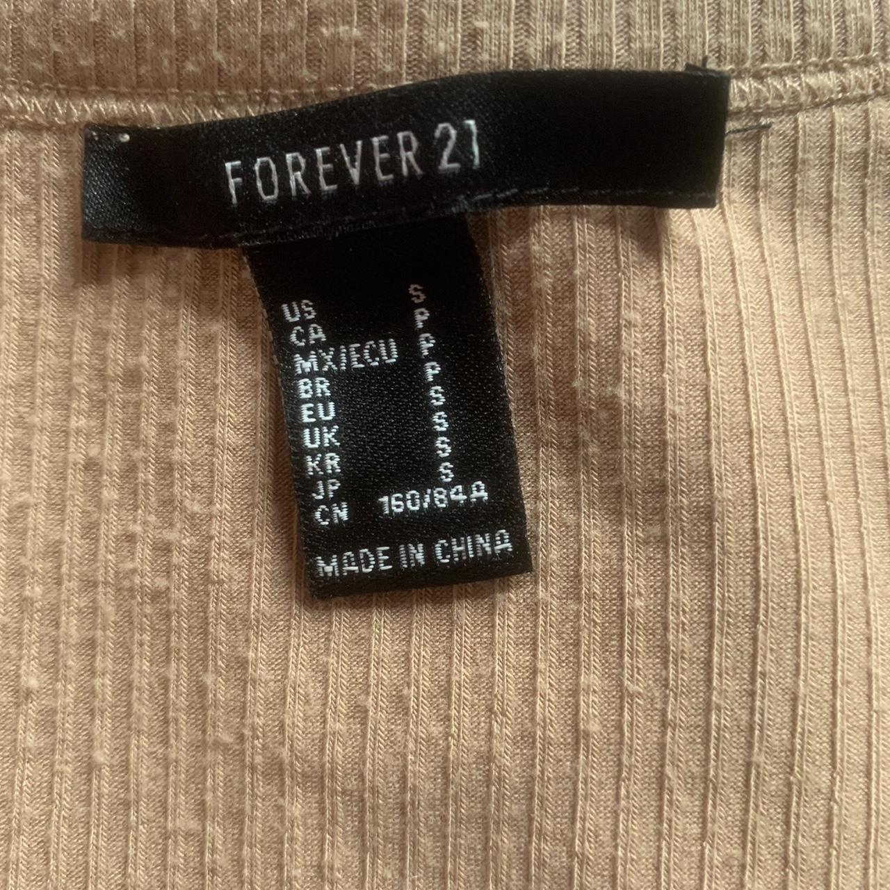 Small tan cropppp, super comfy and makes ur bewbs... - Depop