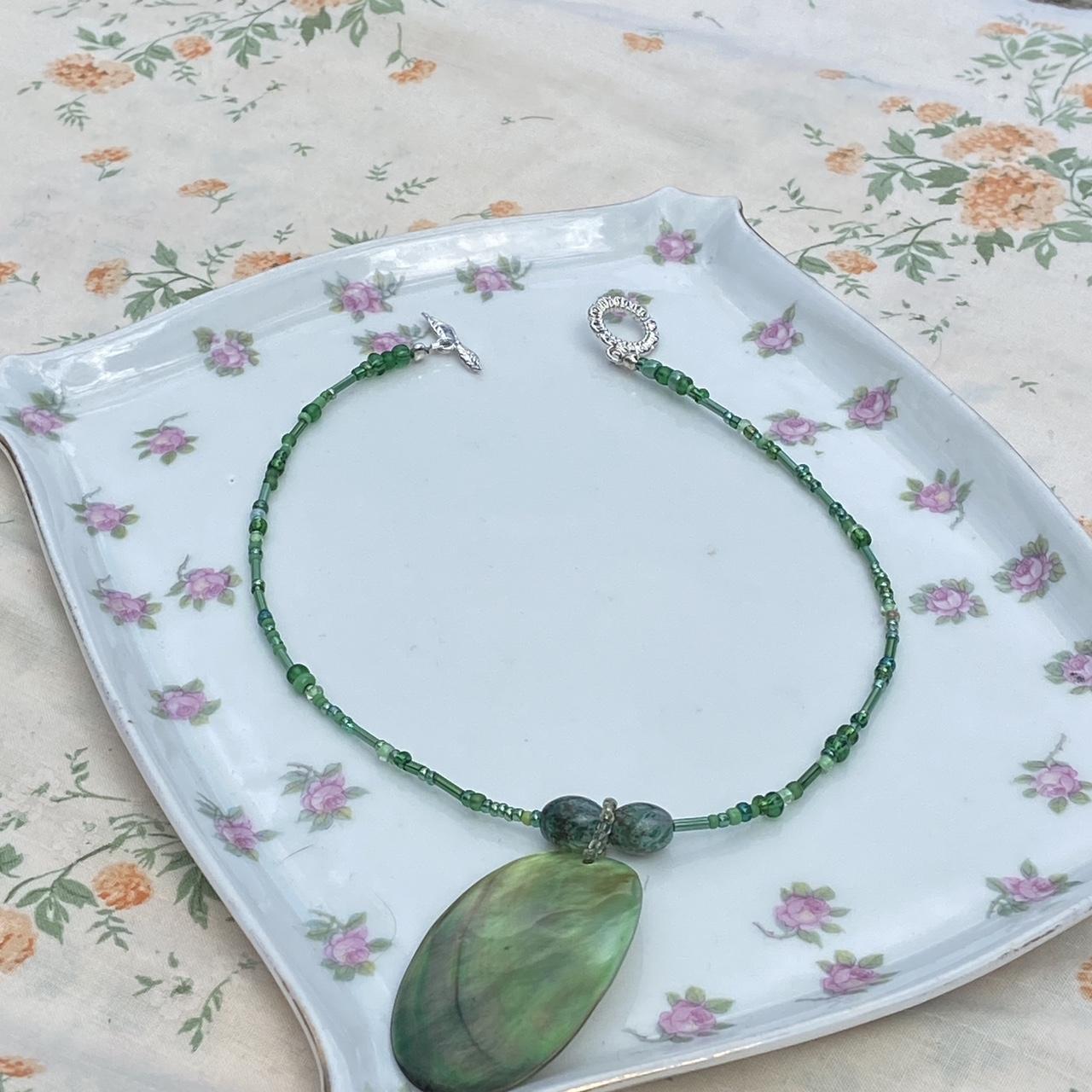 Handmade beaded necklace with a green shell... - Depop