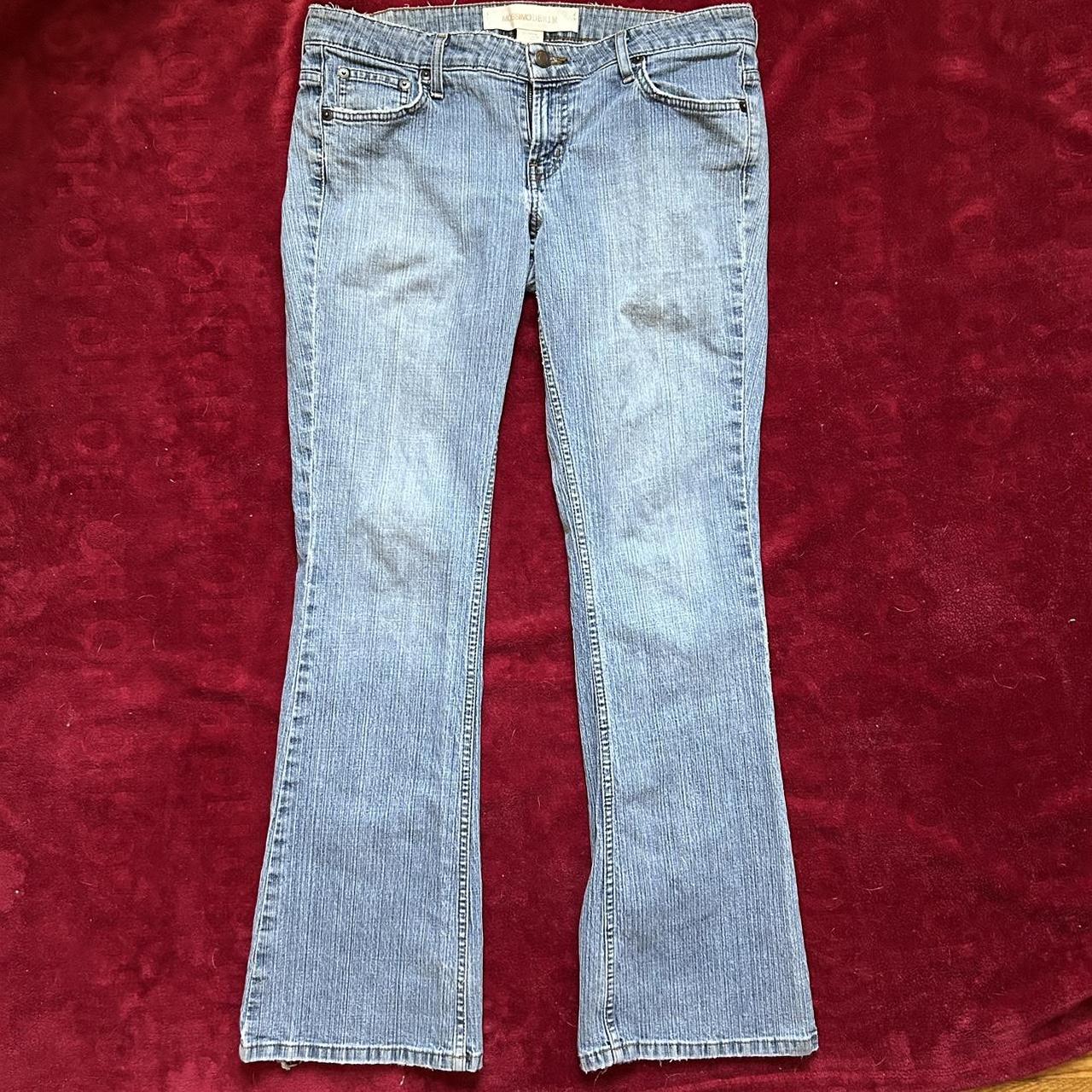 Blue and navy low rise bootcut jeans with a few rips... - Depop