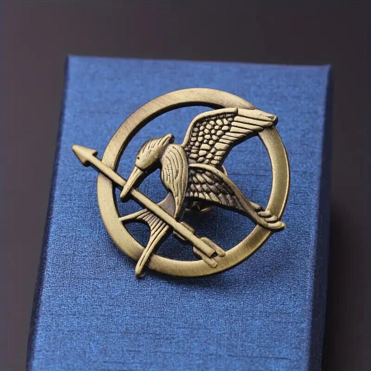 Mockingjay The Hunger Games Round Bird Arrow Pin... | Depop