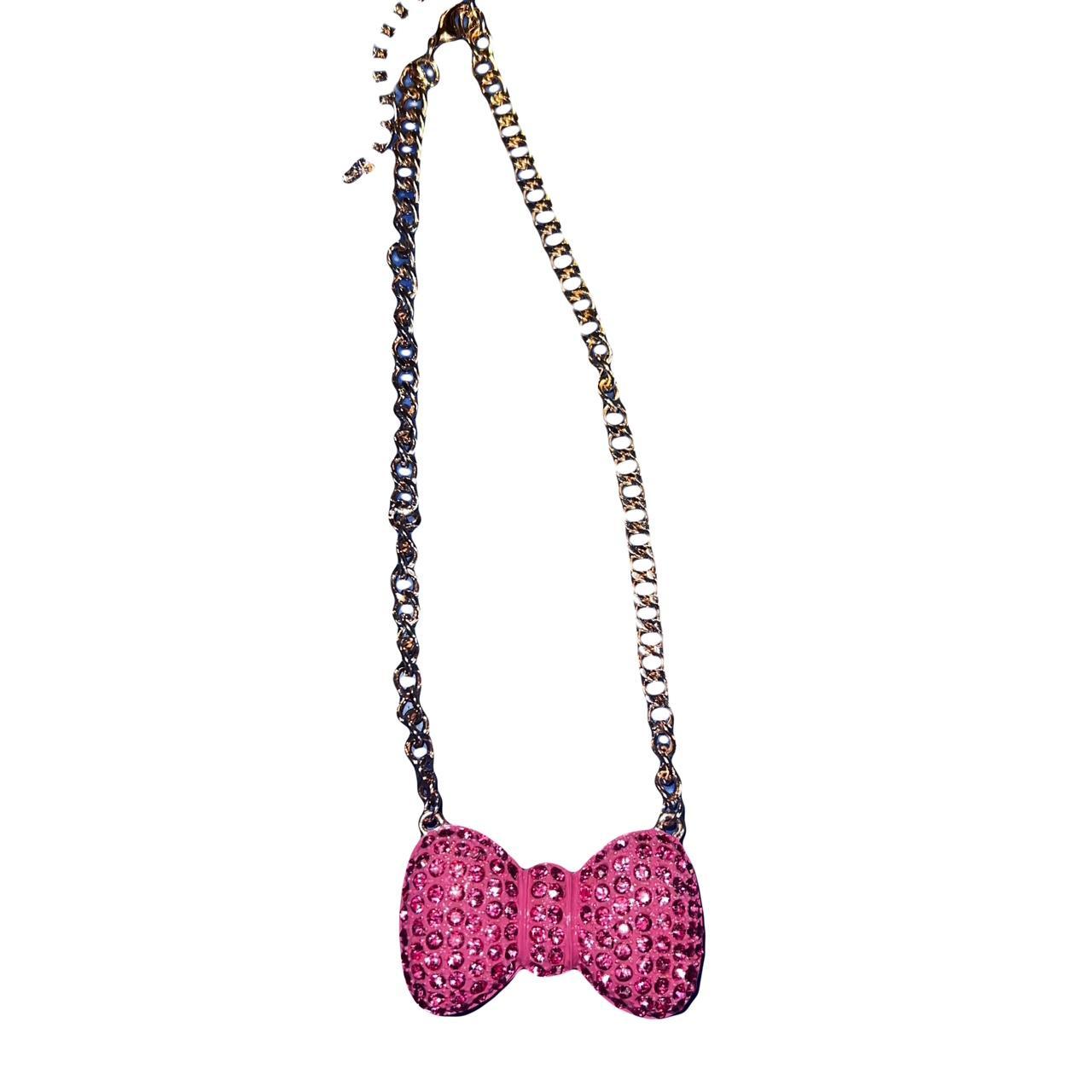 Pink rhinestone bow necklace with a gold chain,... - Depop