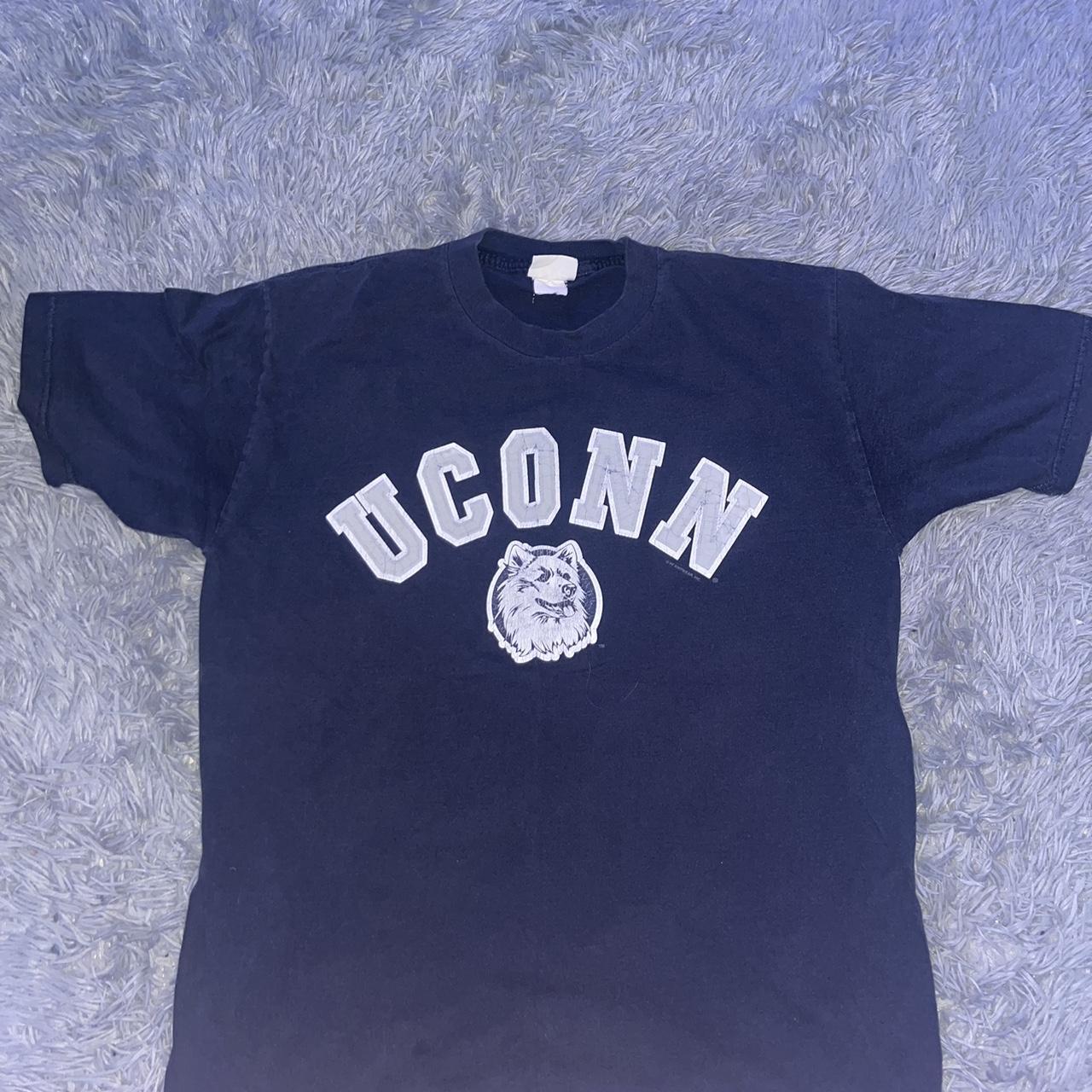 Navy blue uconn graphic t shirt. Letters are cracked... - Depop