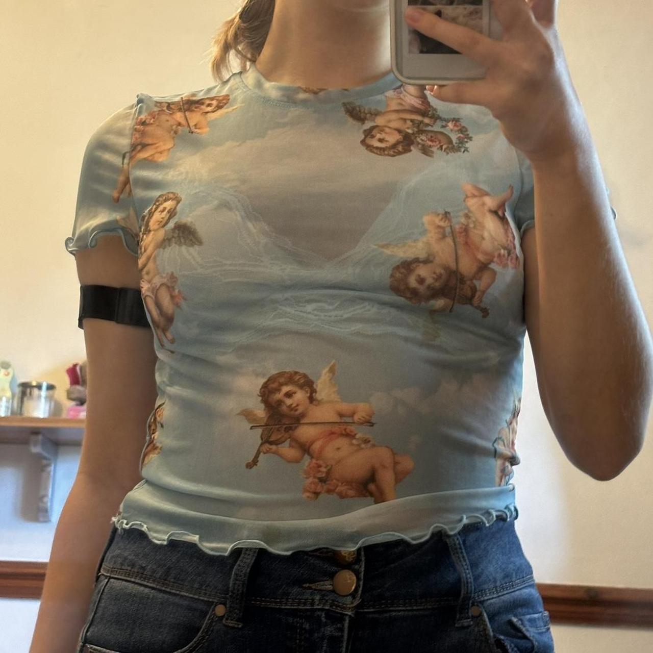 Mesh blue sky flying angels patterned top Size... - Depop