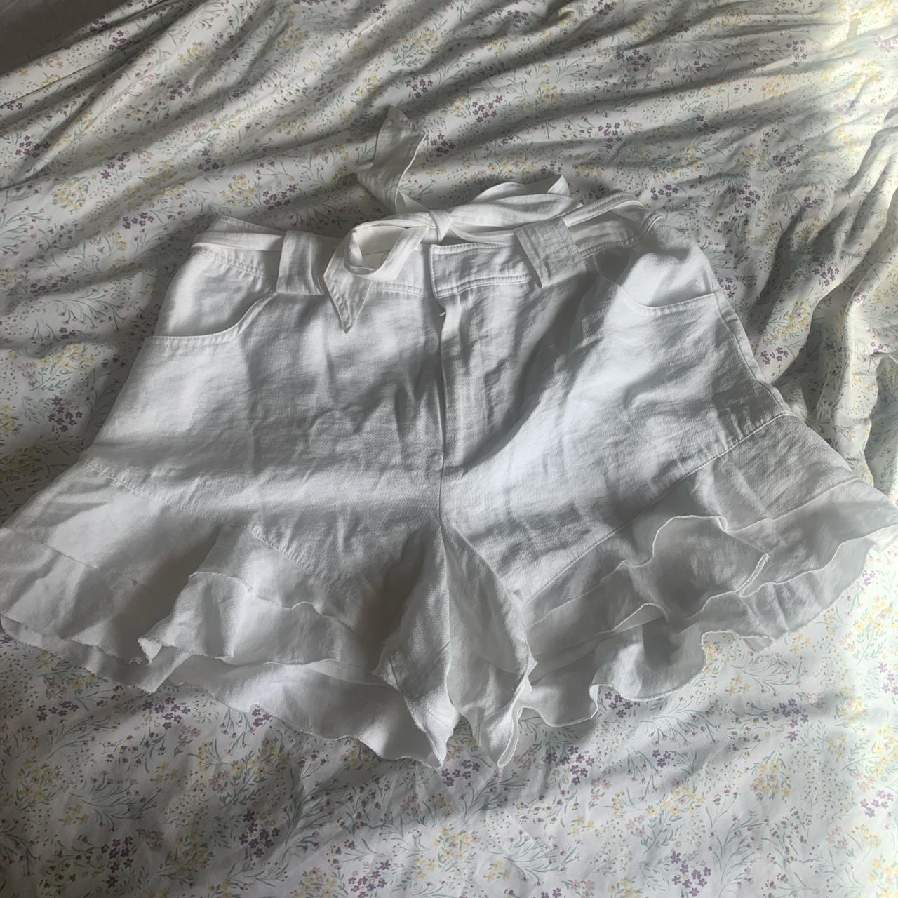 White “Cece” shorts with ruffles on bottom of shorts - Depop