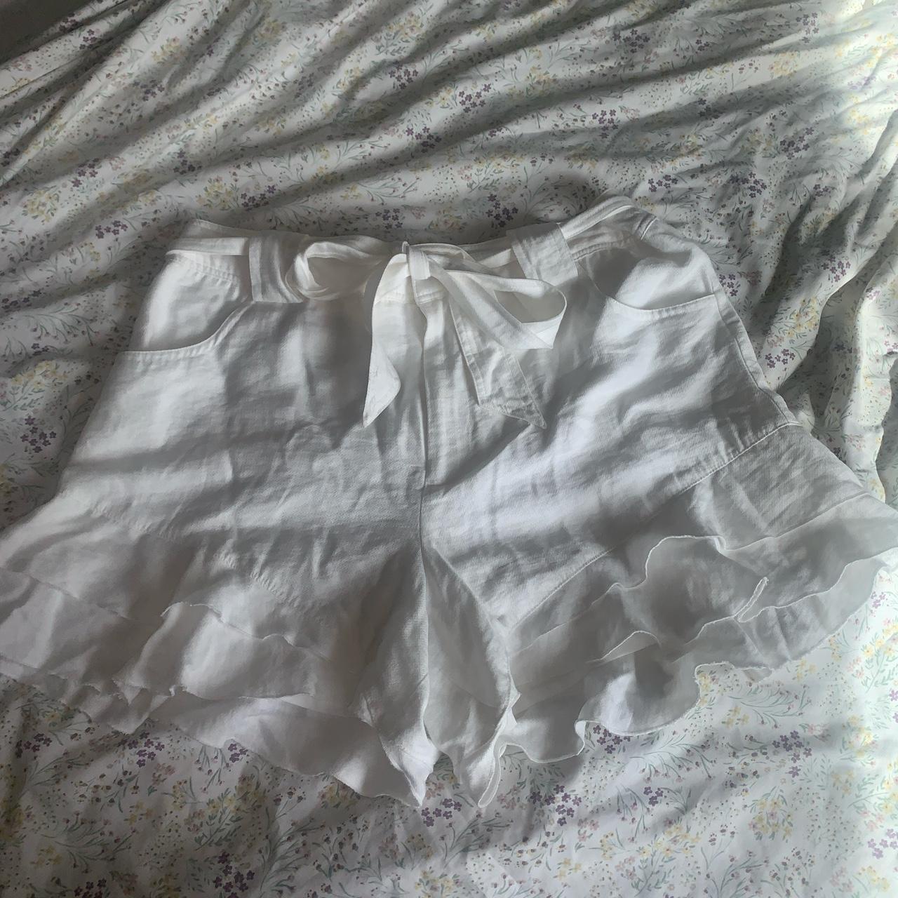 White “Cece” shorts with ruffles on bottom of shorts - Depop