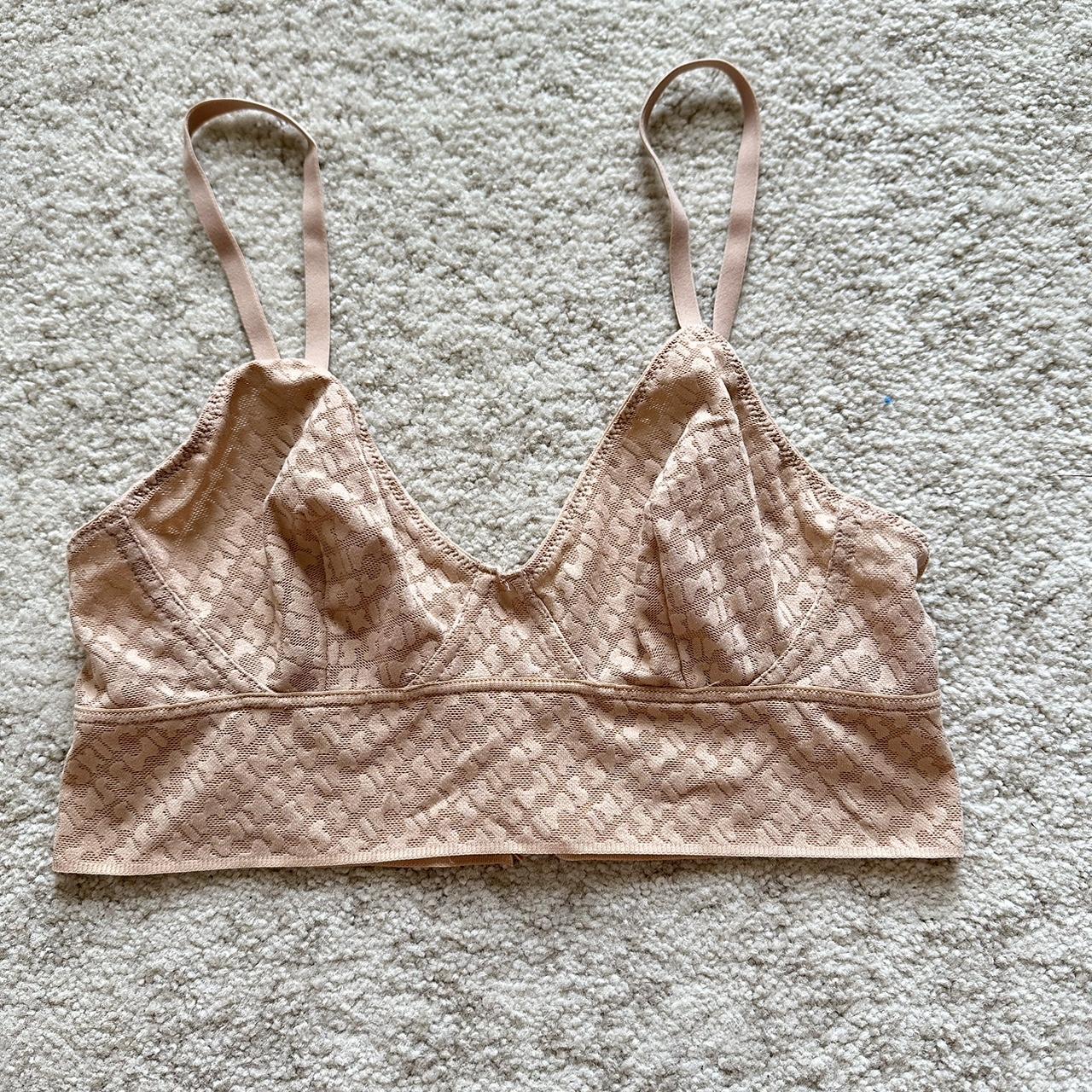 Skims nude bralette with a SKIMS logo pattern and... - Depop