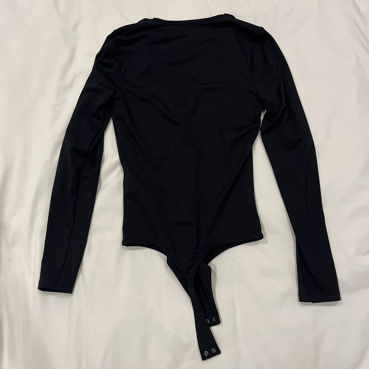 tight fitting, long sleeved body suit -deep v neck... - Depop