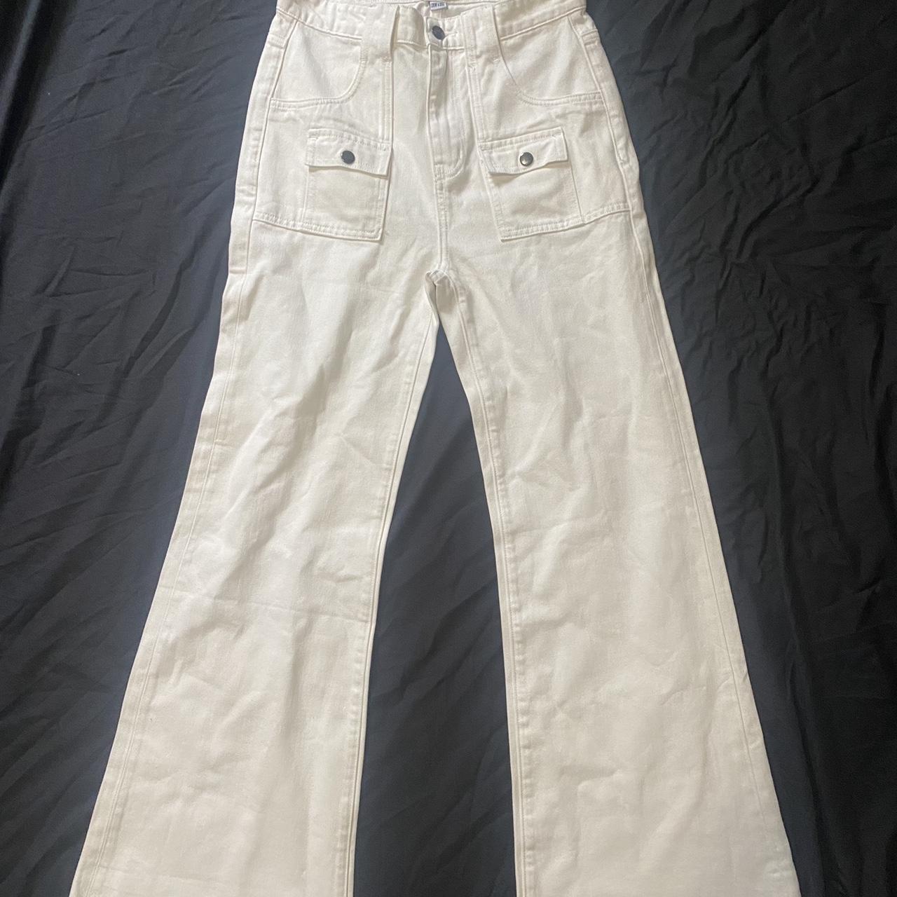 White flared jeans distressed at the bottom brand... - Depop