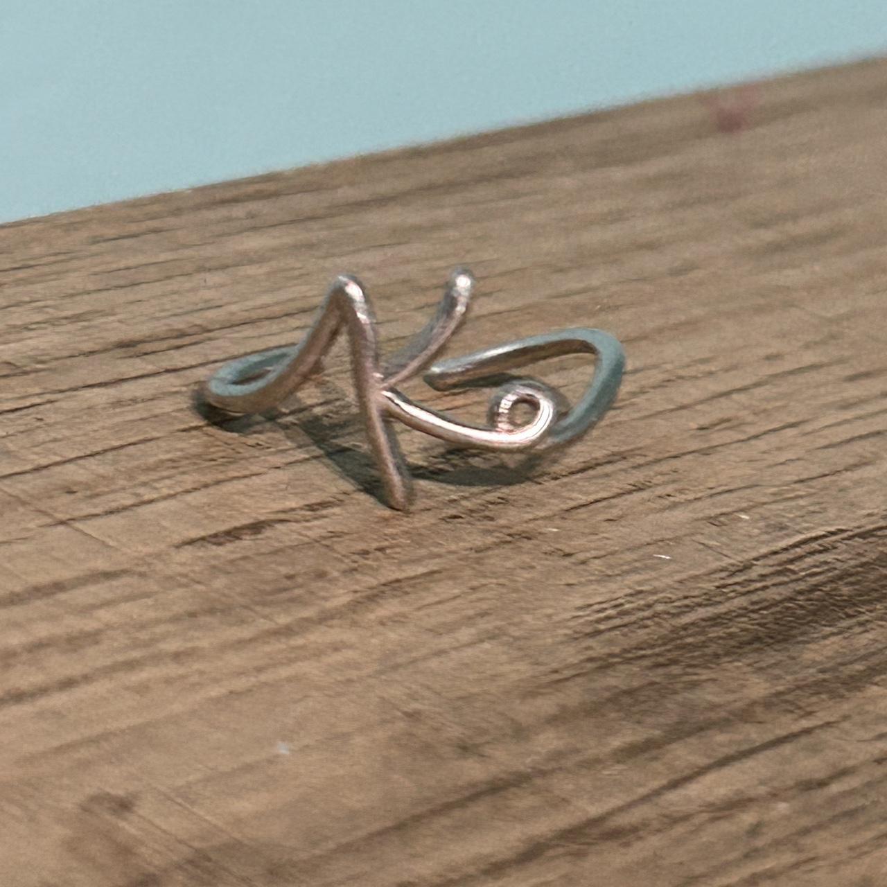 Silver K ring. It’s adjustable so it can fit pretty... - Depop