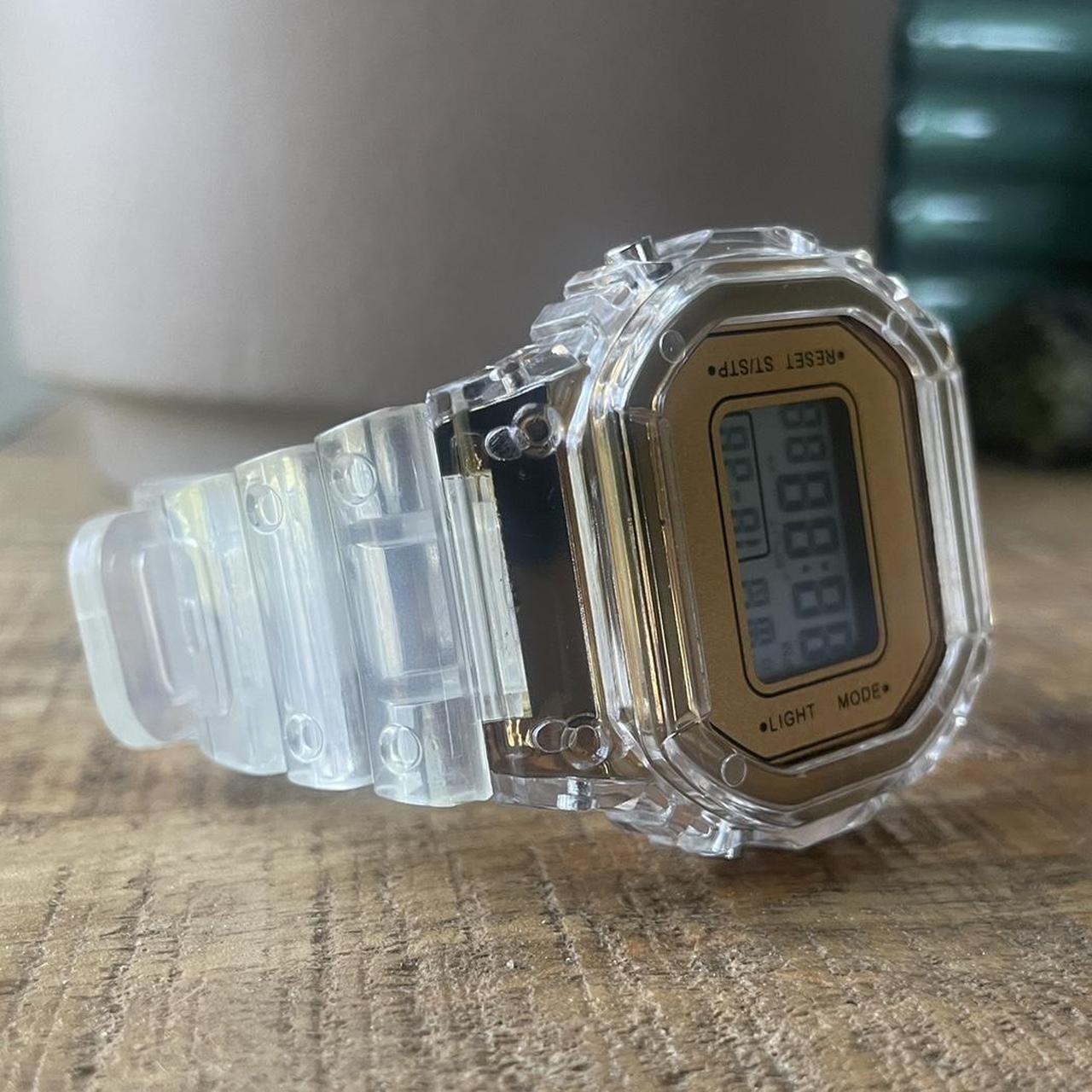 Chunky digital watch with gold face and clear... - Depop