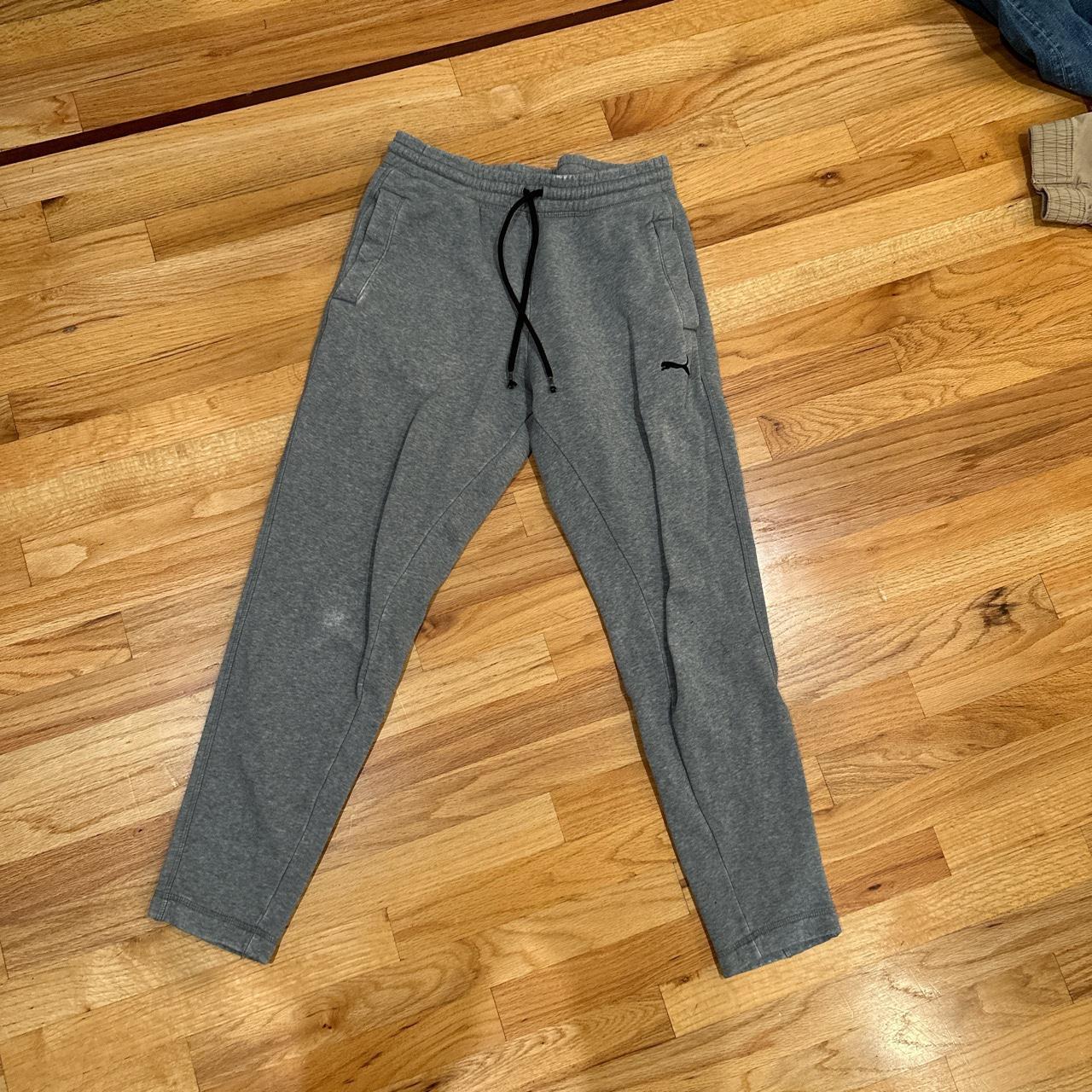 Puma grey sweatpants, medium, wear in the material... - Depop