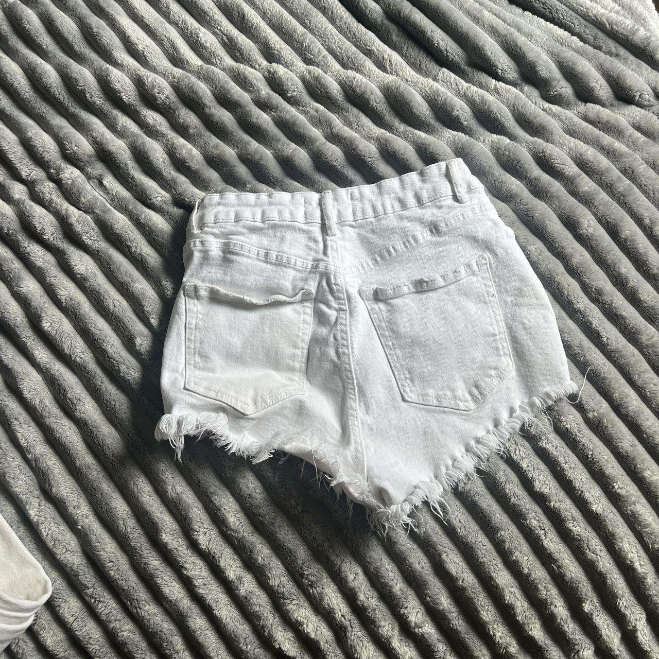 white jean shorts size 4 with a small rip style .... - Depop
