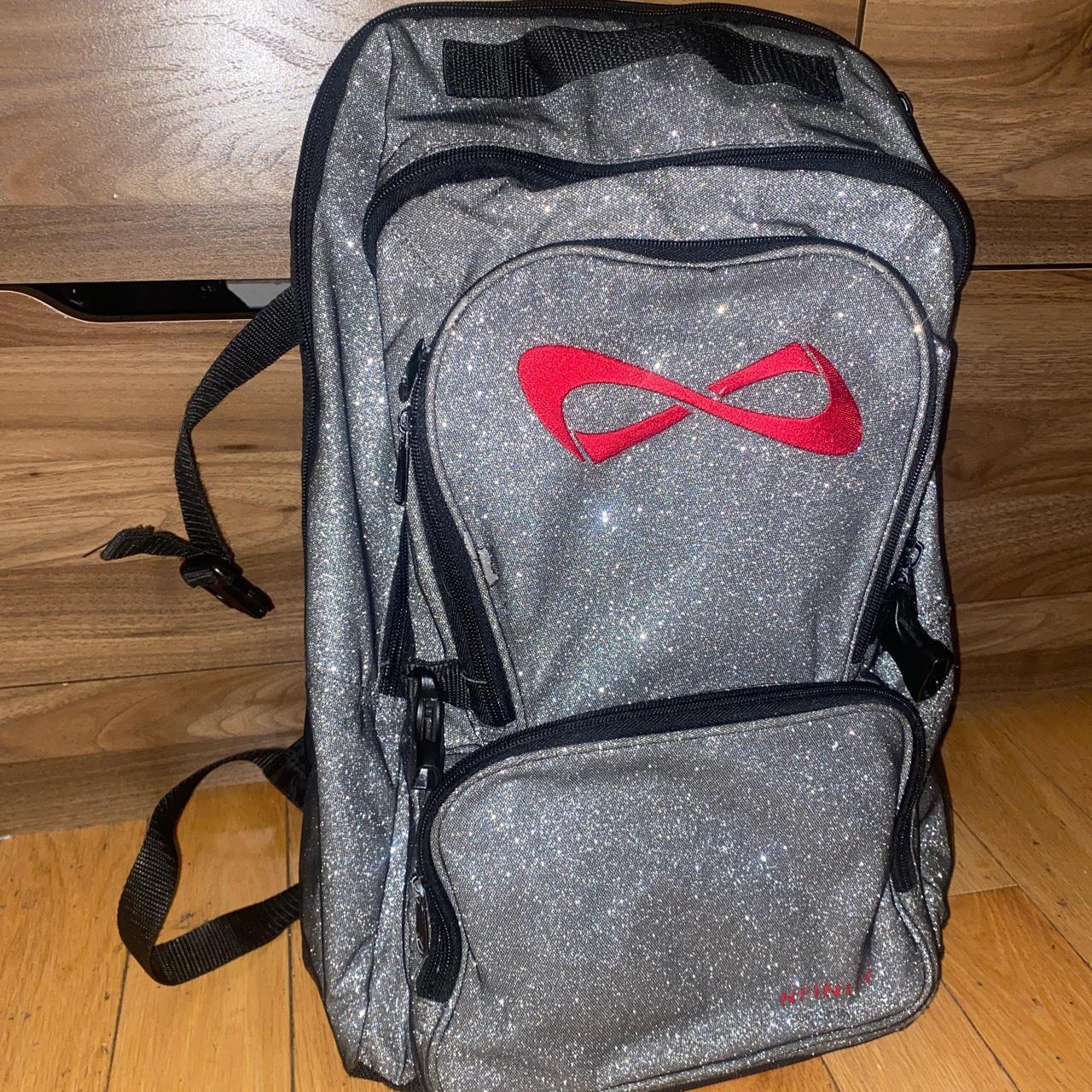Silver Nfinity BackPack with Red infinity sign. Some... - Depop