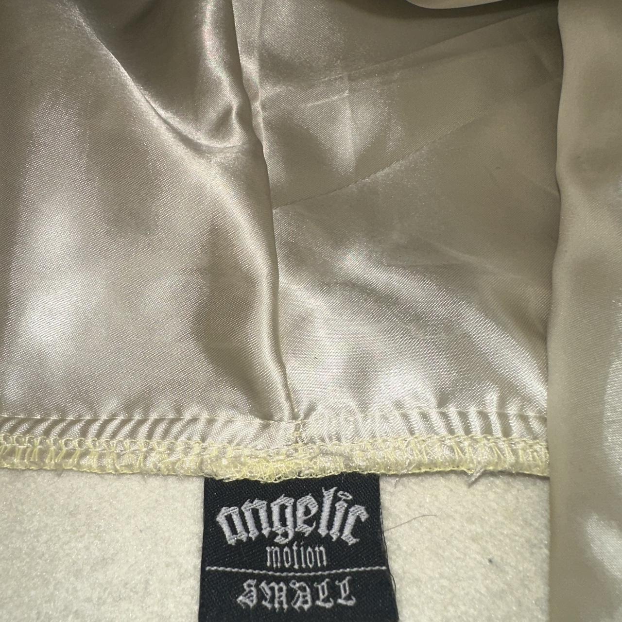 Angelic Motion Zip Up Cream - Depop