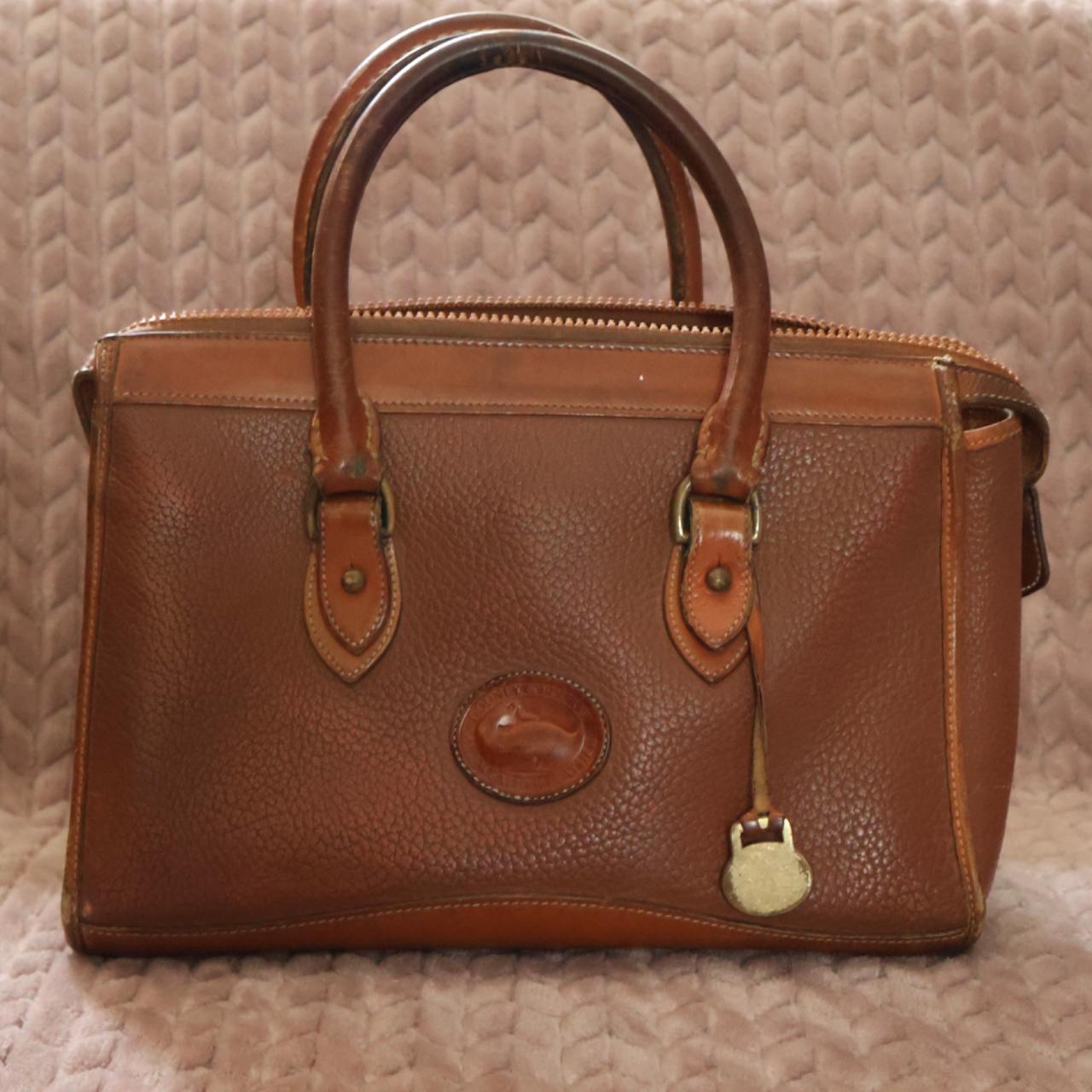 Brown Dooney & Bourke Purse slight wear and tear on... - Depop