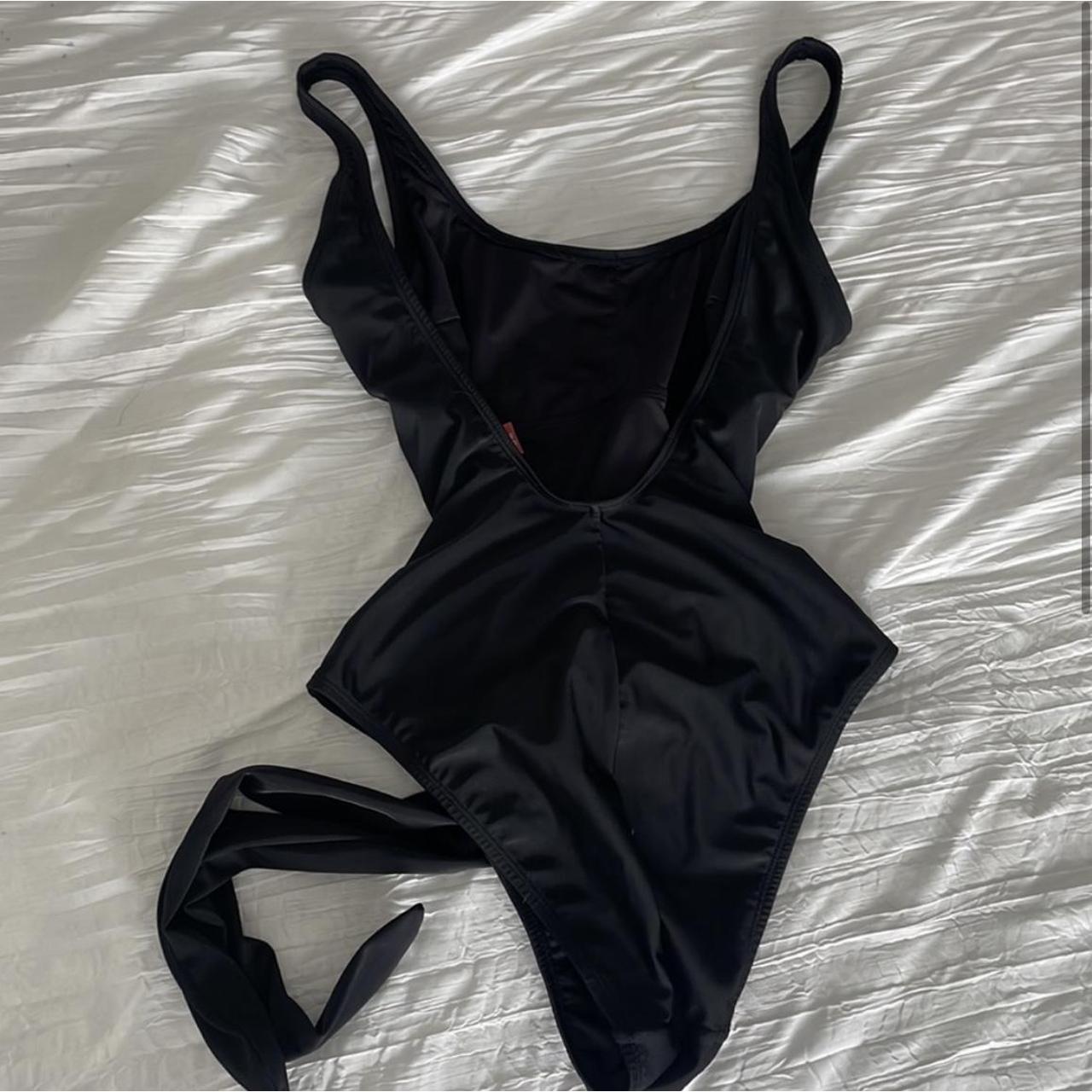 One piece black bathing suit that ties at the waist... - Depop