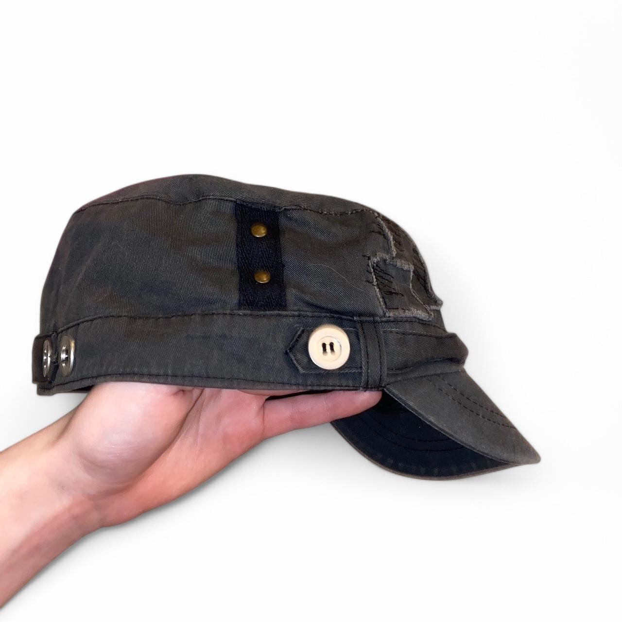 Black distressed hat with button detailing... | Depop