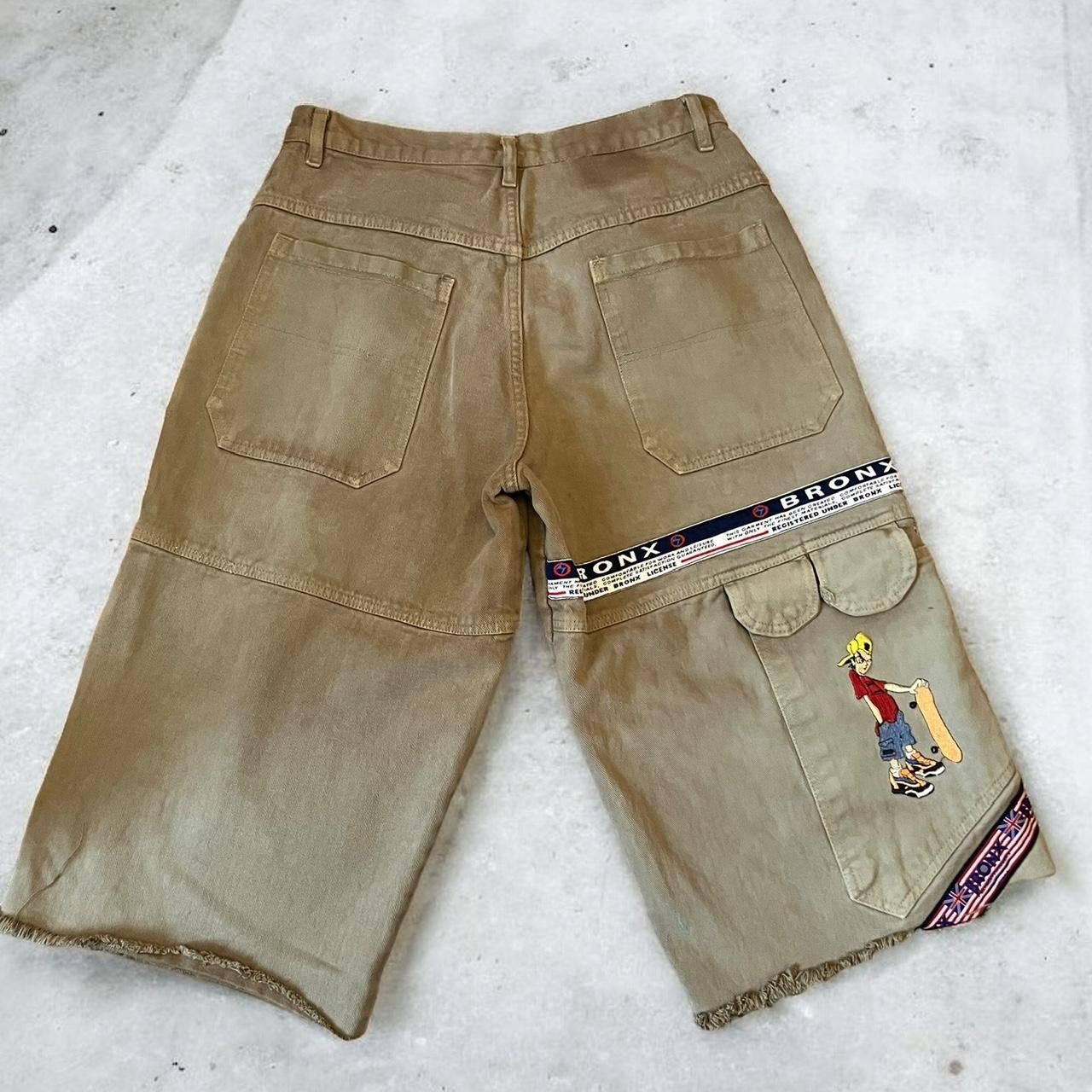Tan long jorts with a relaxed fit, featuring a... - Depop