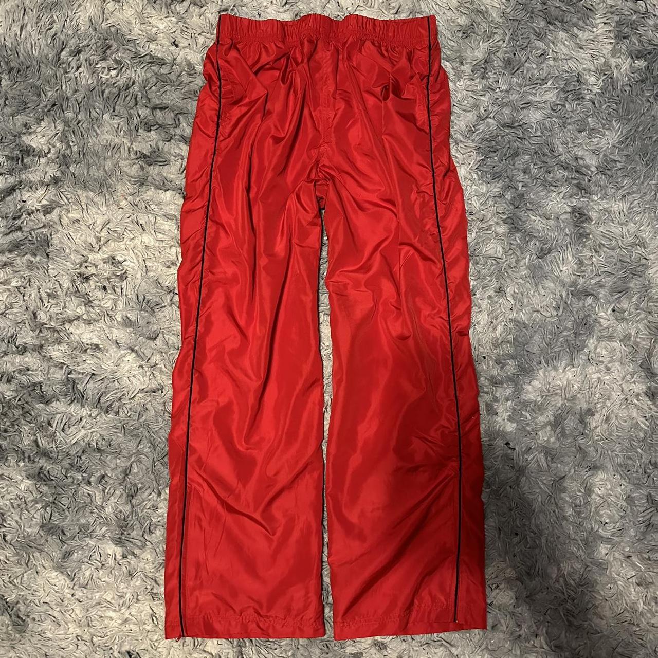 Red track pants with black stripe | The tag say size... - Depop